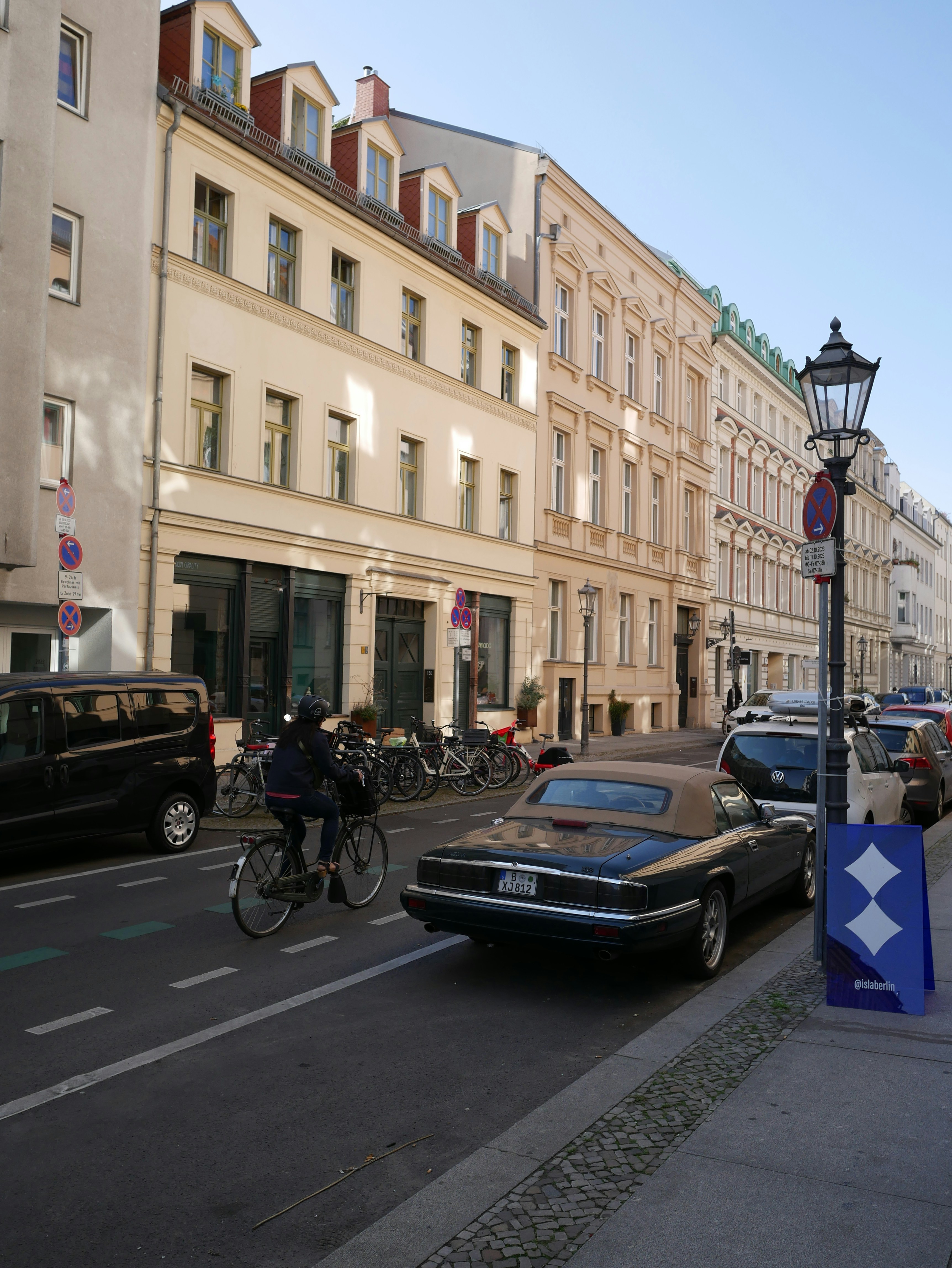 City Lane in Morning Light: Classic Cars and Bicycles Under Historic Facades