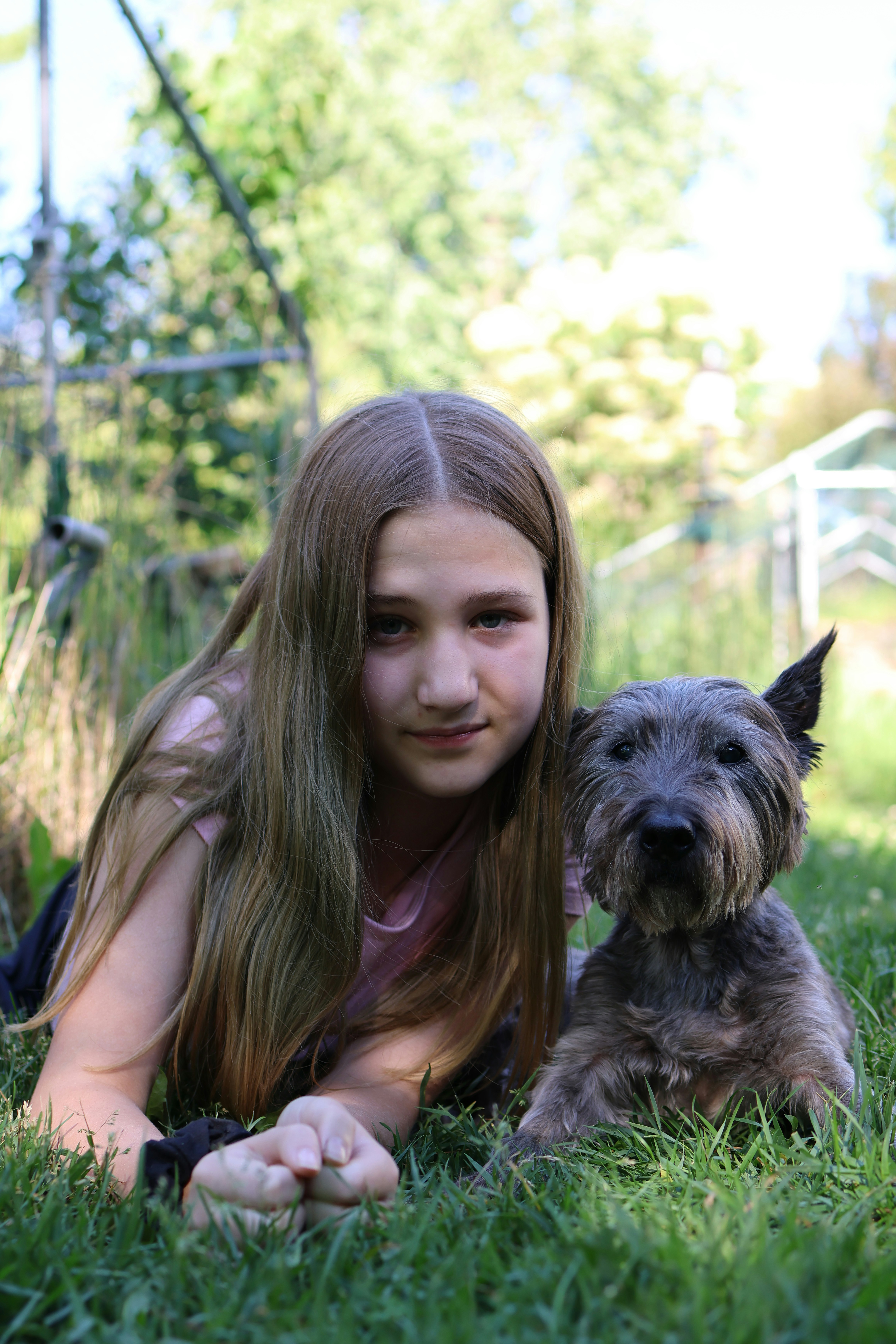 Young Girl and her Cairn-like Companion: A Quiet Backyard Moment