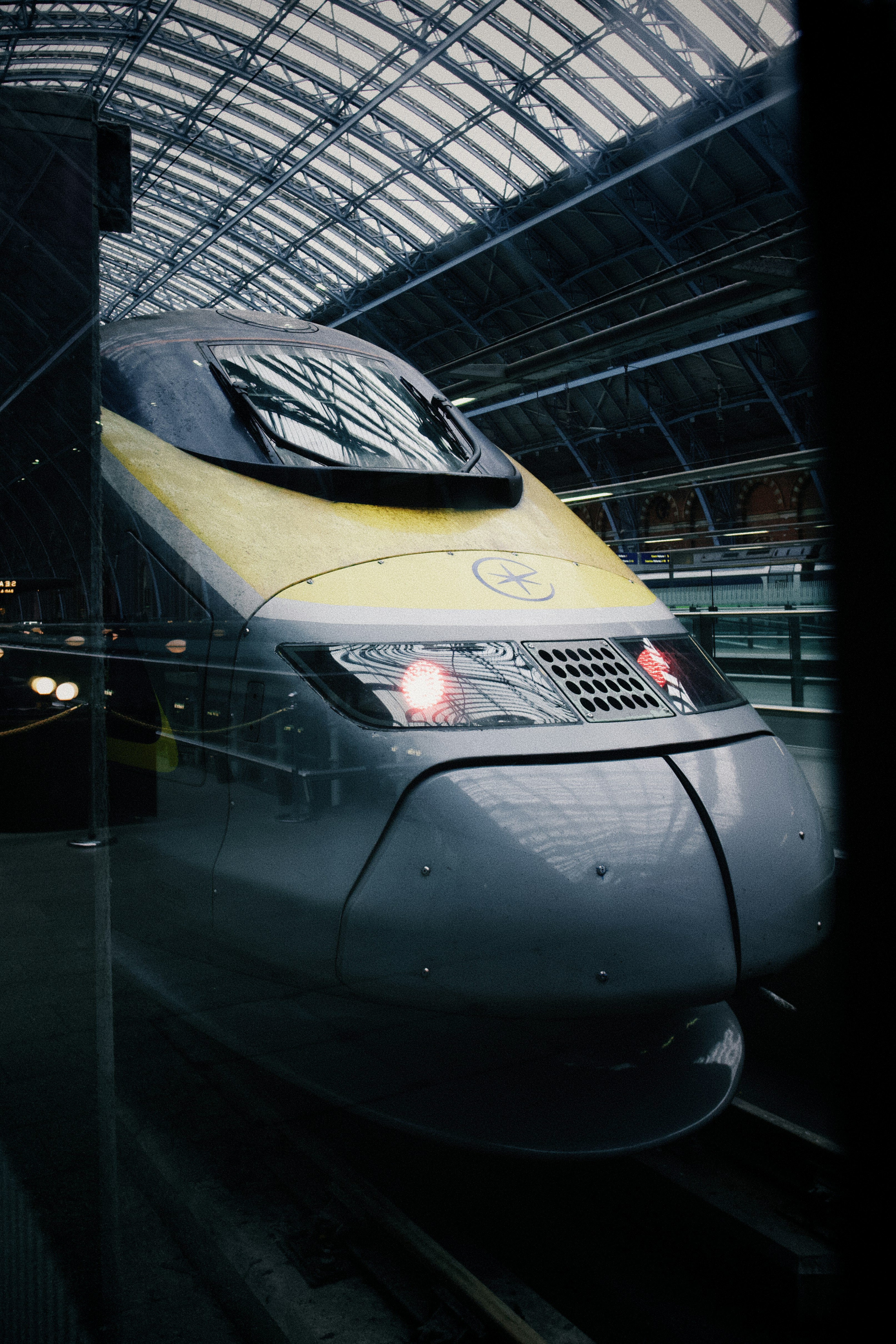 Front-On Glimpse of a High-Speed Train in a Glass-Cky Station