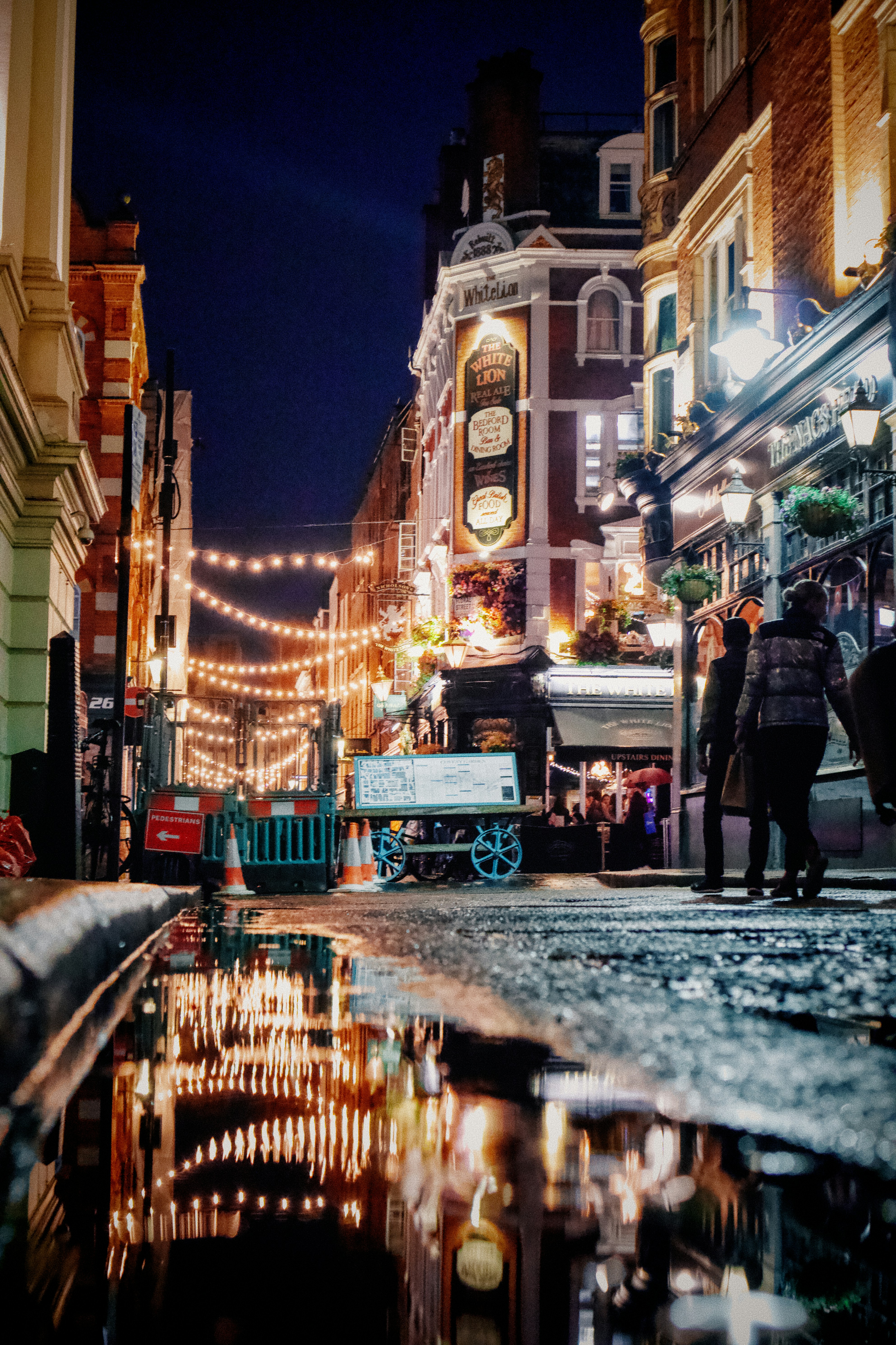 Twilight Lane: Lanterns and Reflections in a Cobblestone Alley