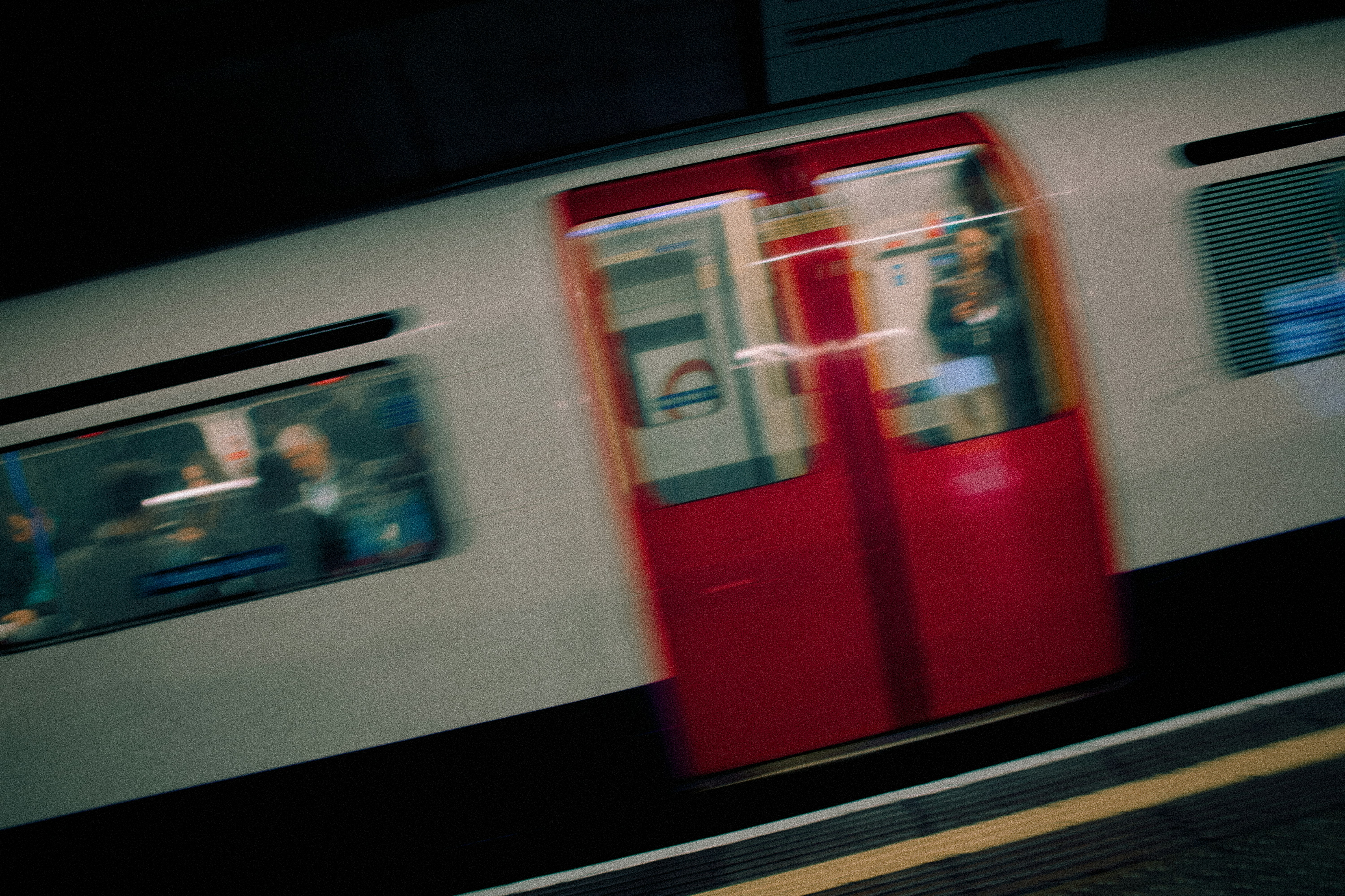 Blurred Transit: red door of a subway car in motion