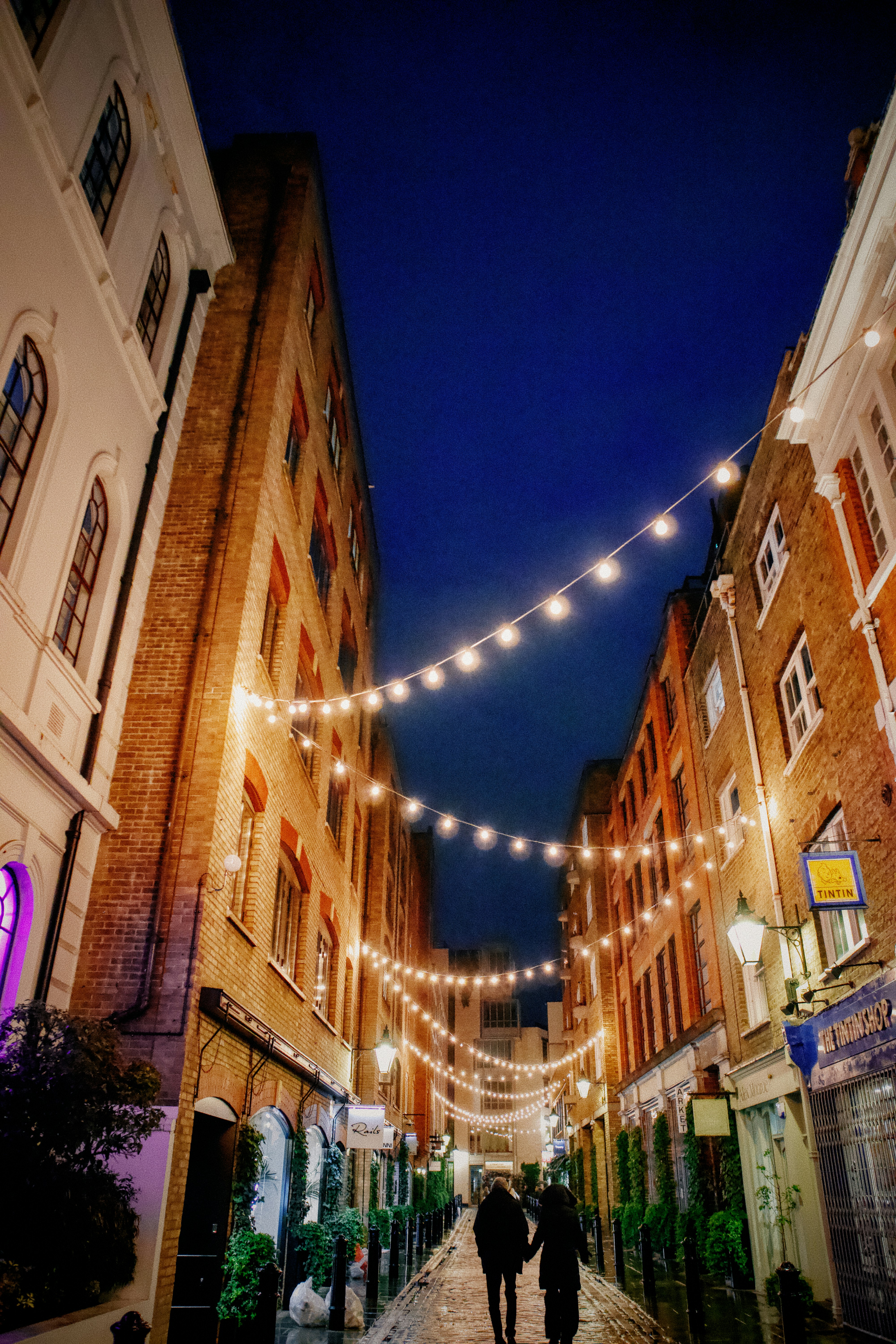 String Lights Over a Cobblestone Lane: Evening Walk Through a Cozy City Alley