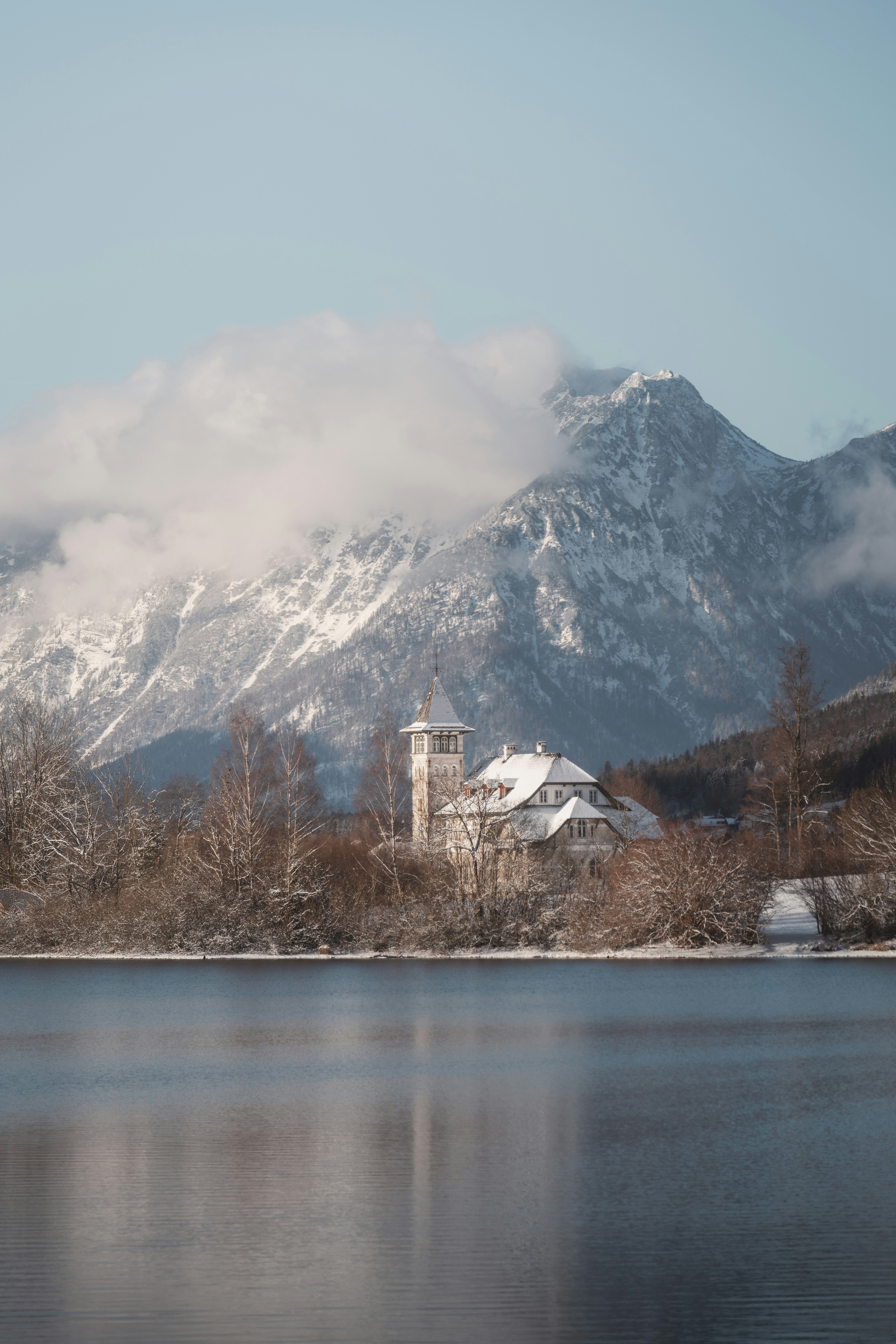 Snowbound Chapel by the Lake under Alpine Peaks