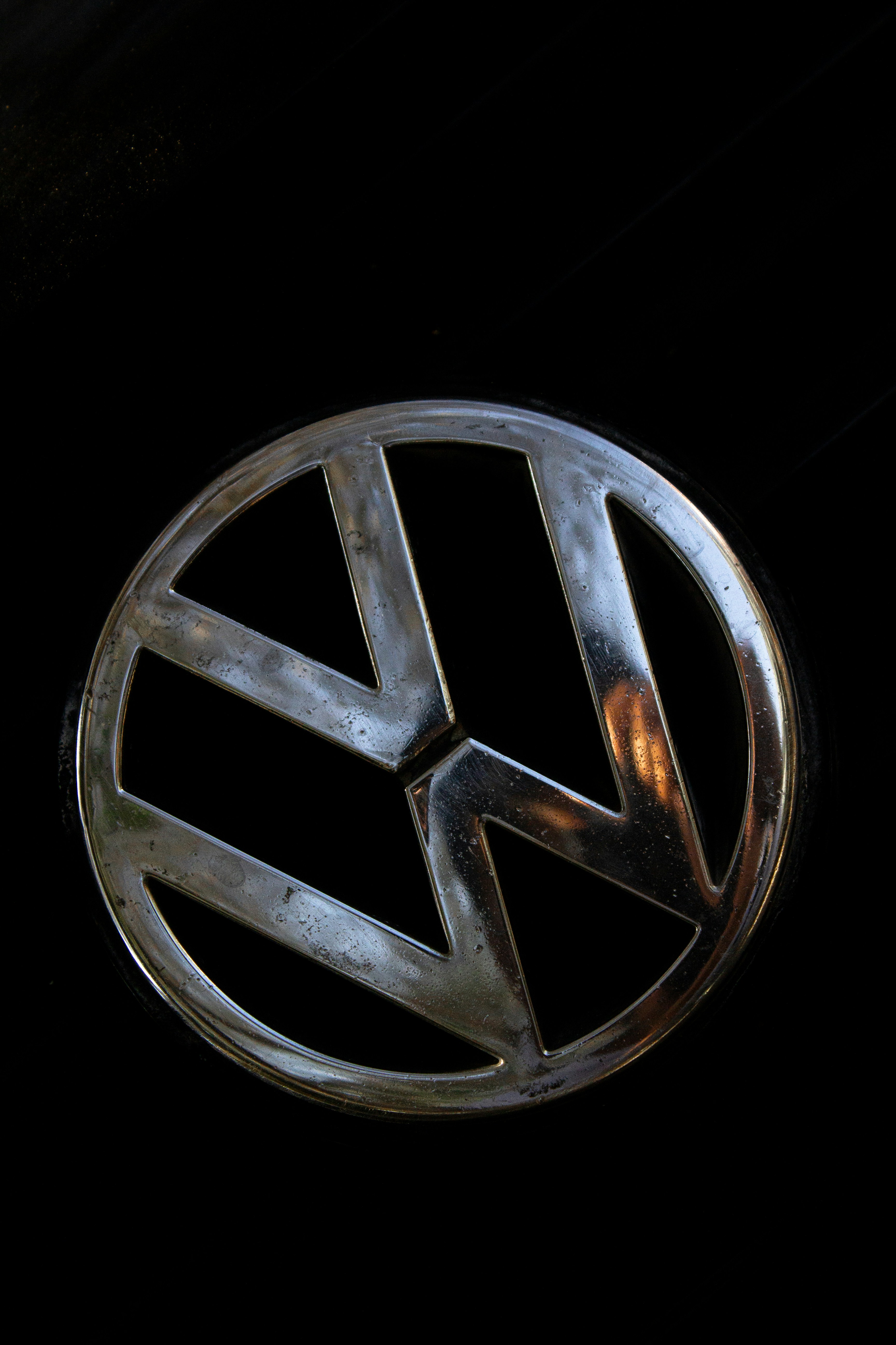 Polished Emblem in Void: The VW Crest on a Night Backdrop