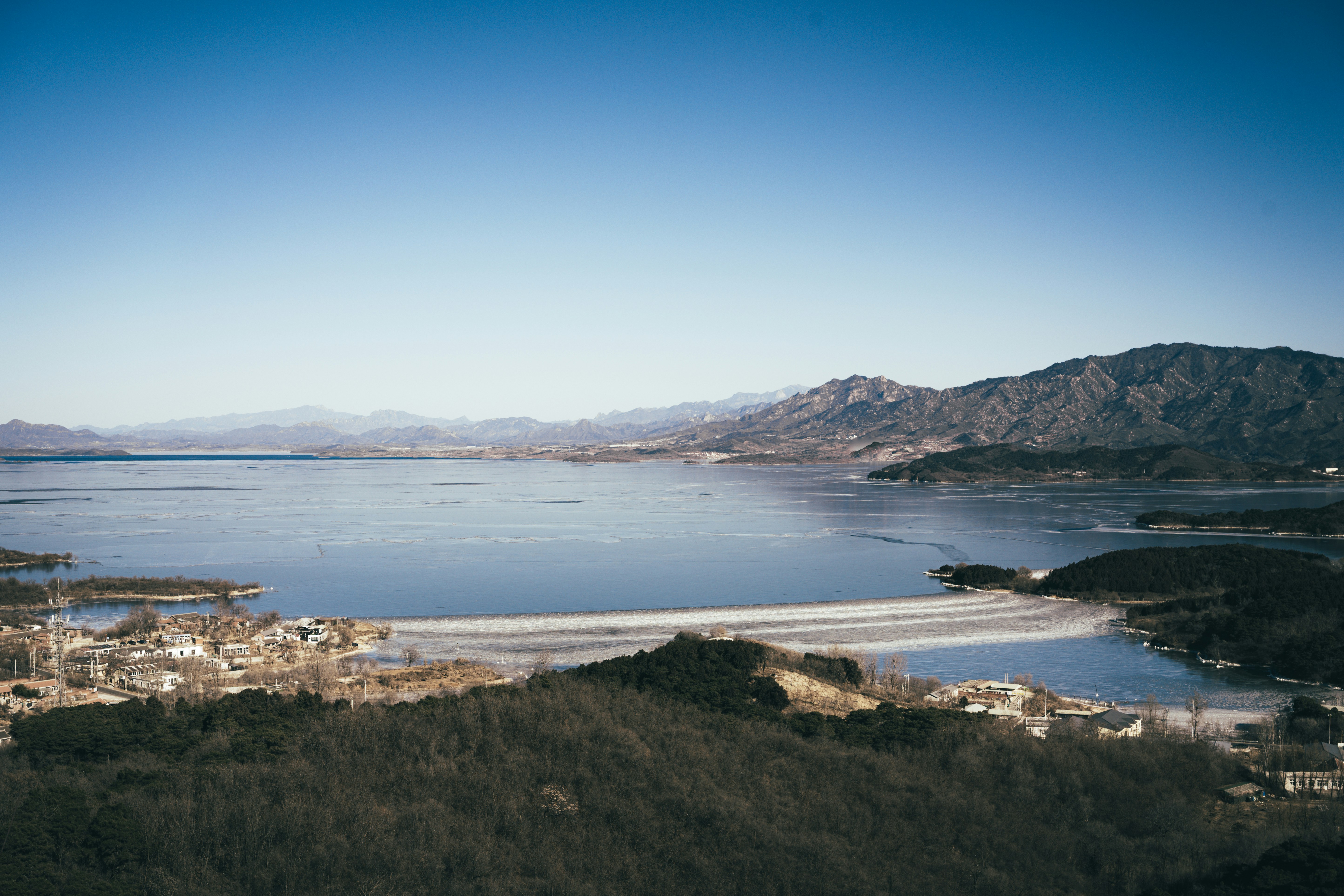 Quiet Coastal Basin Between Rolling Hills and Distant Peaks