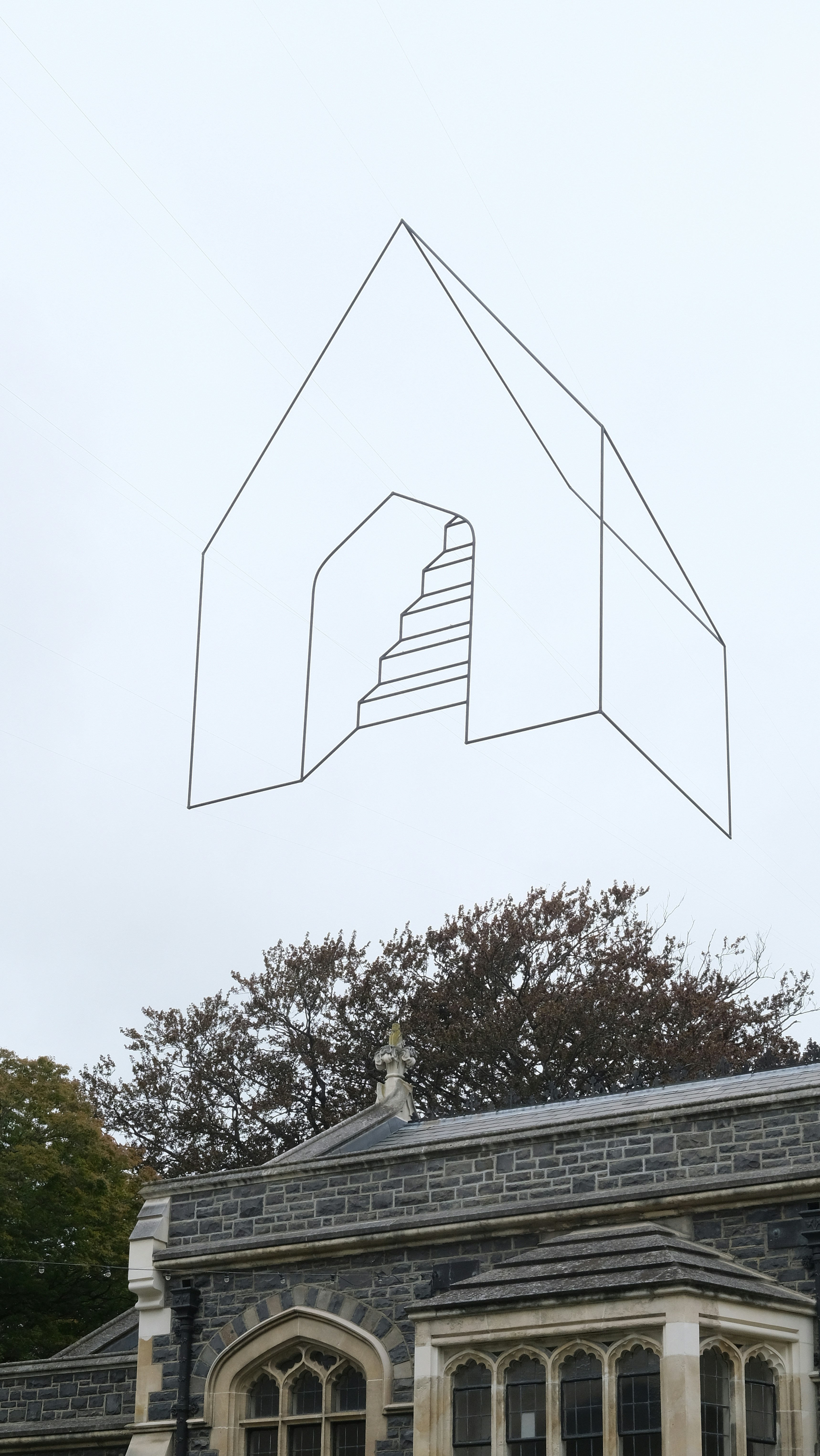 Wireframe Staircase Arch Soaring Above a Historic Façade
