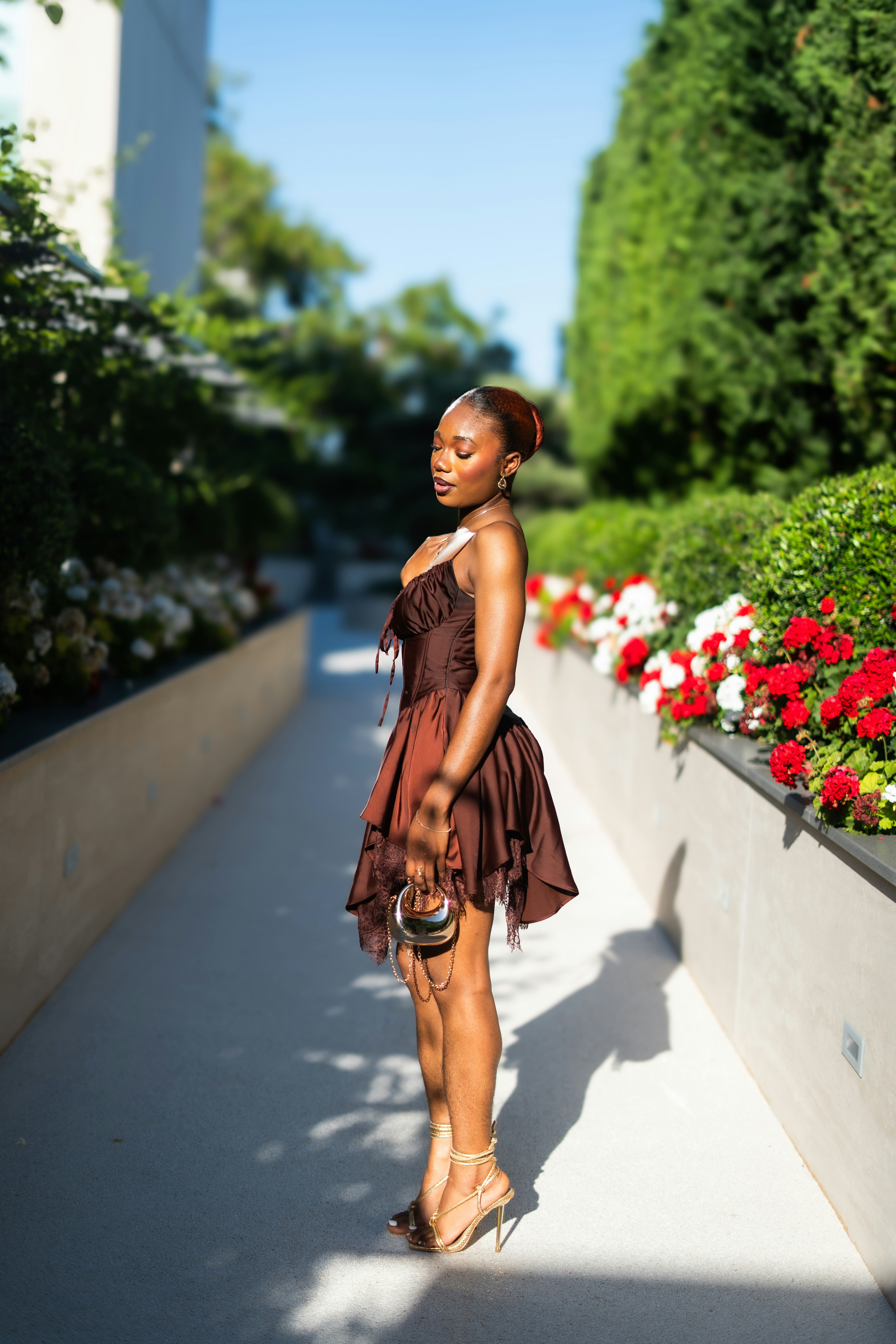 Evening Porcelain: A Poised Portrait Along a Blooming Terrace