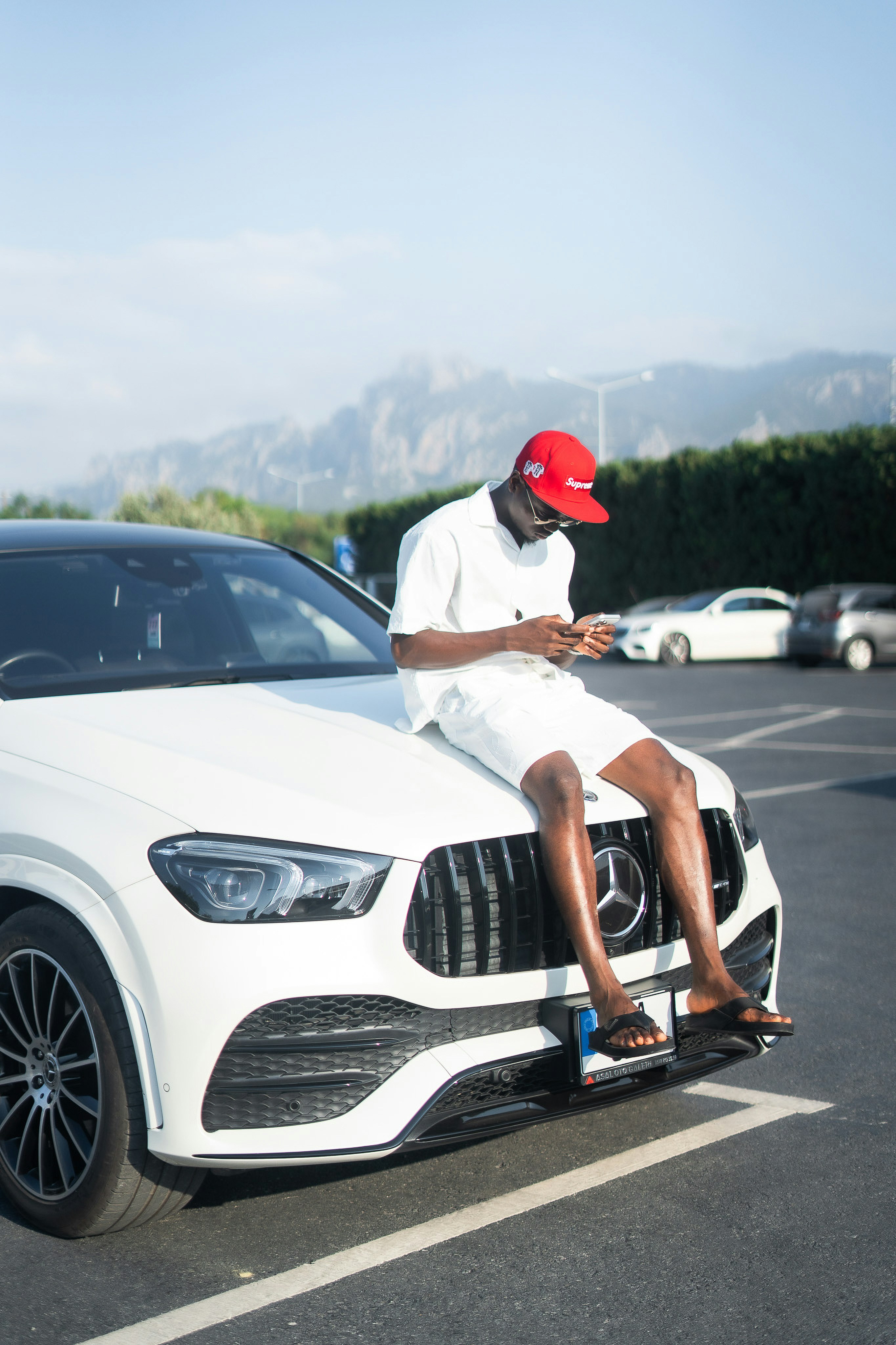 Casual Moment: A Rider Seated on a White SUV