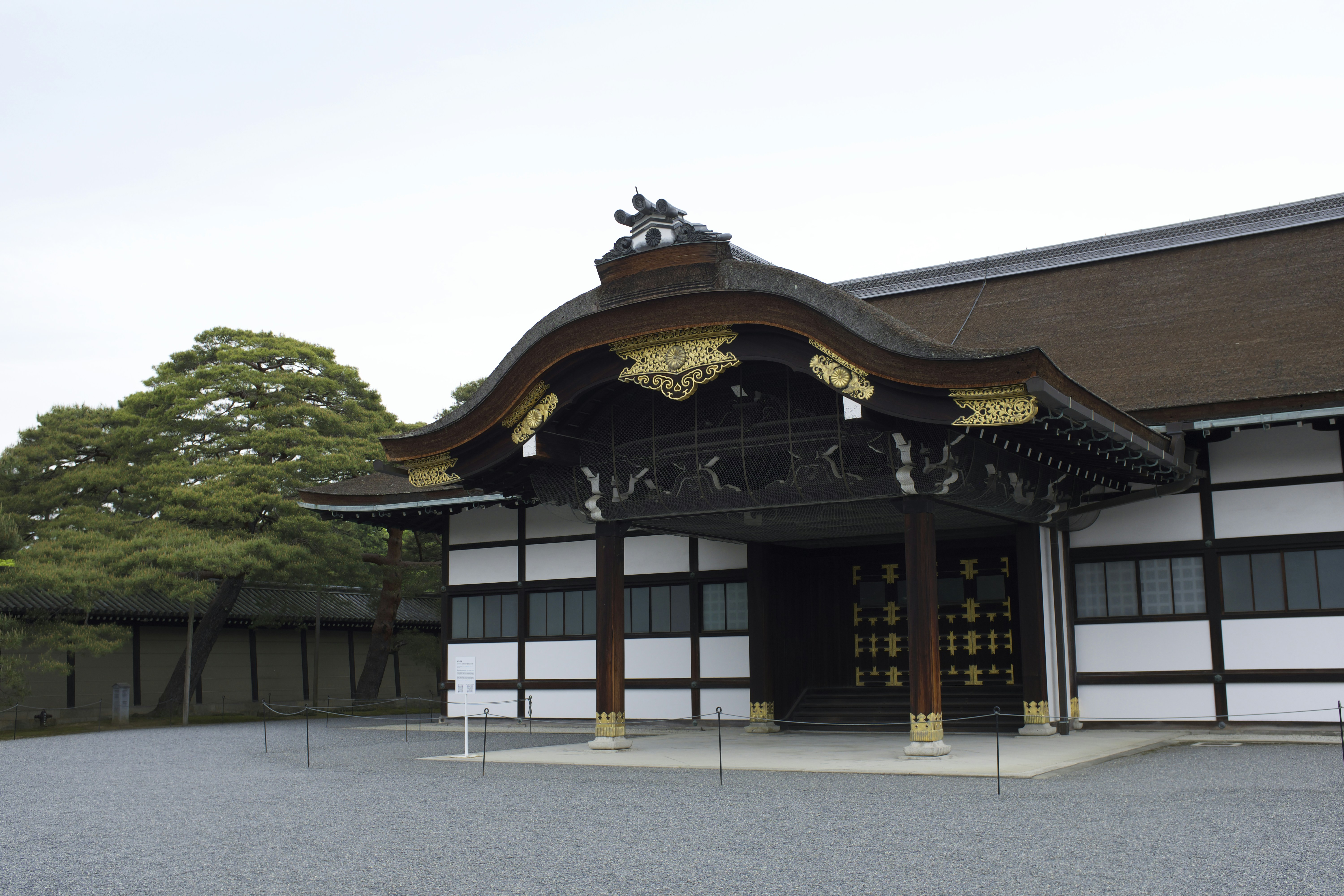 Temple Facade with Open Entrance and Ornate Roof Crest