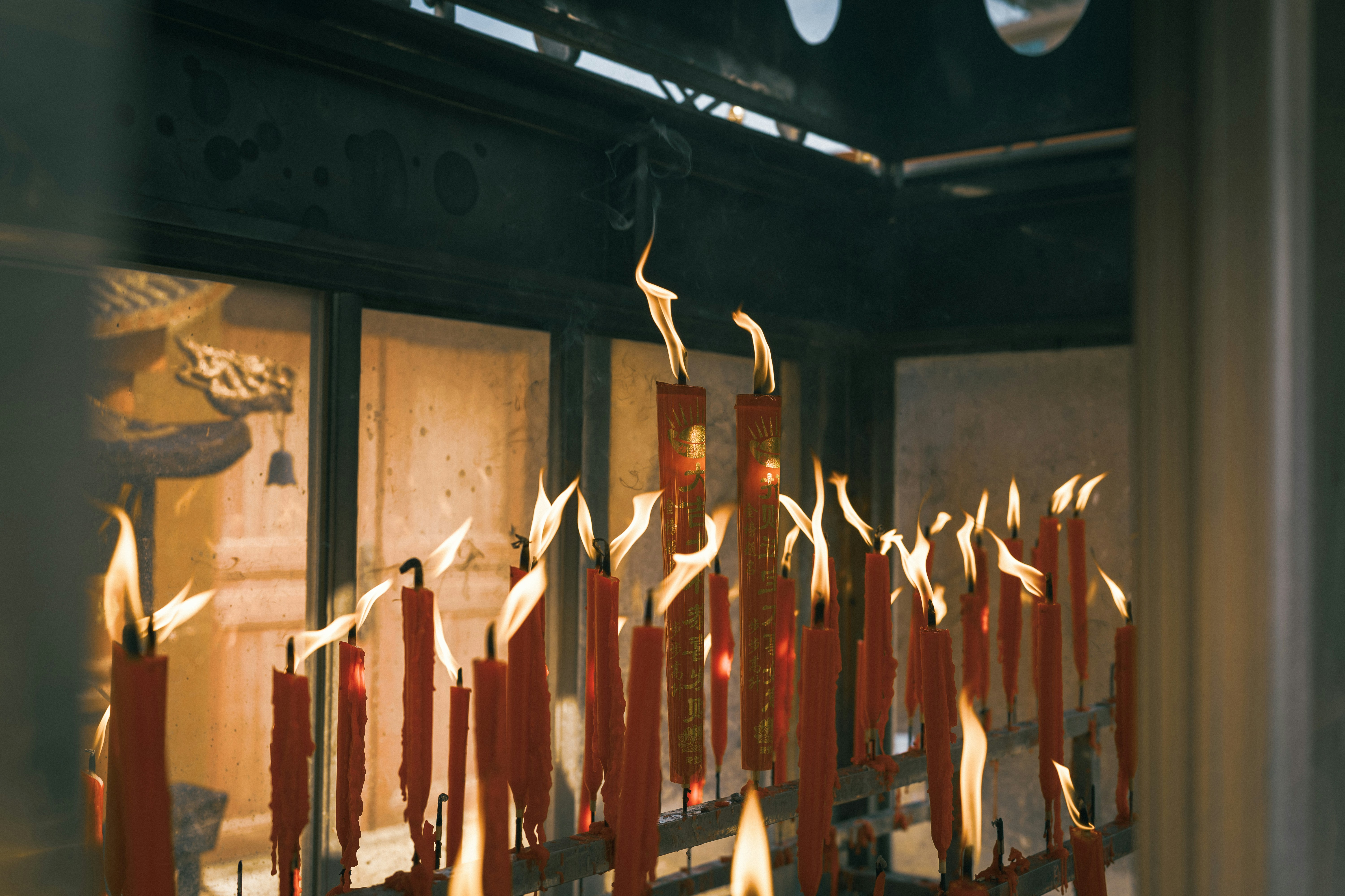Flickering Offerings: A Row of Candles in a Quiet Shrine