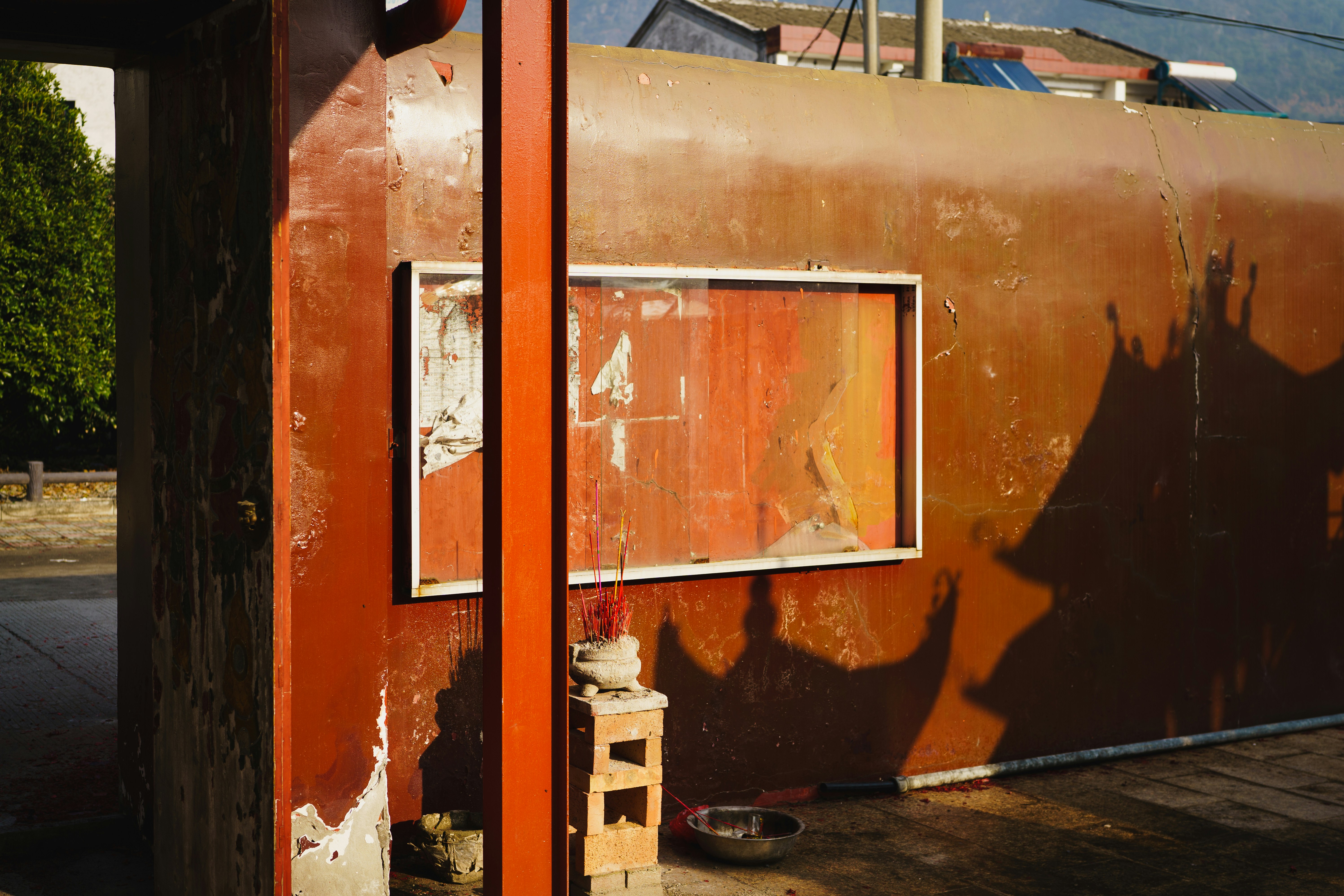 Sunlit Rust: Shadowed Wall and Framed Window