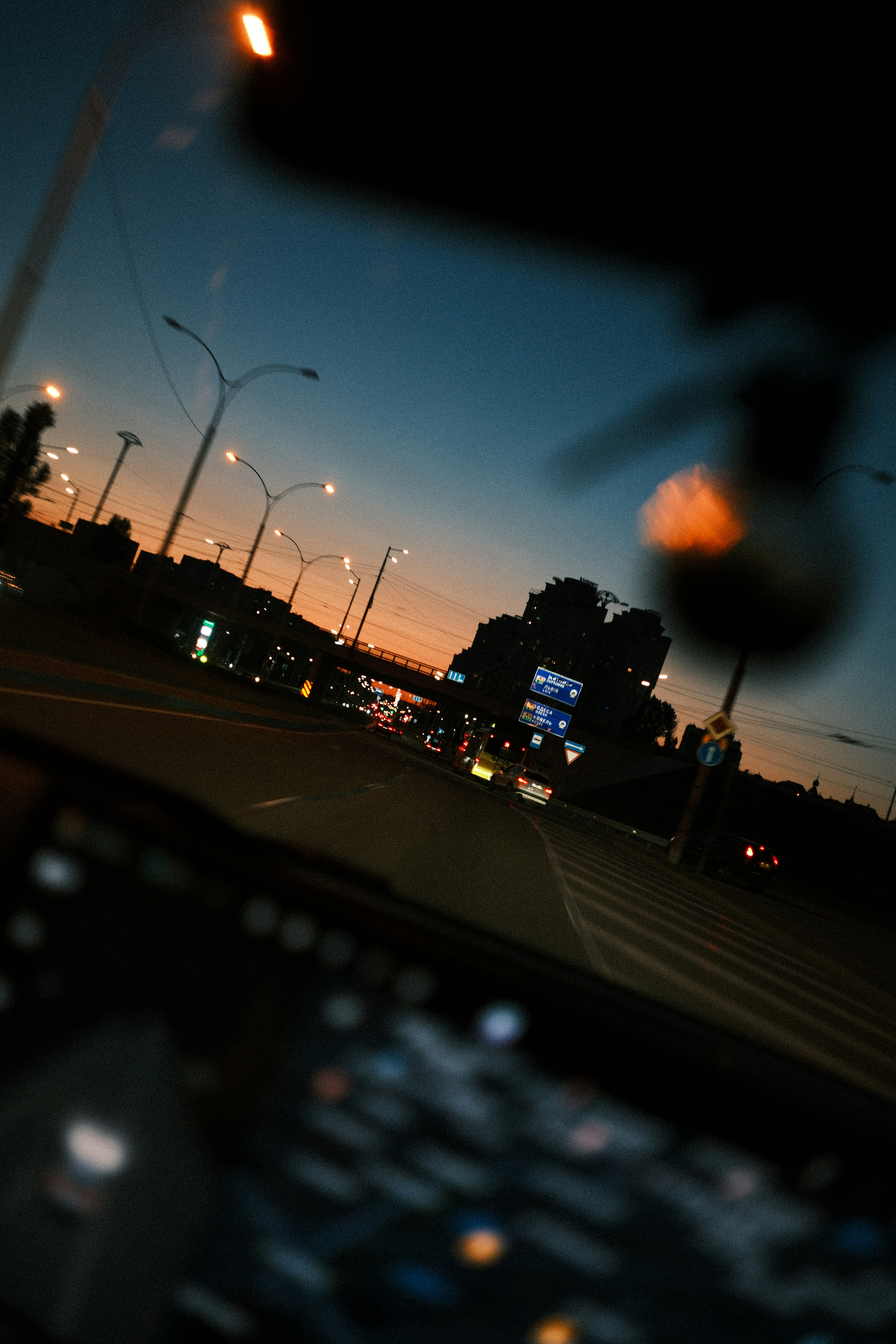 Dusk Drive: City Skyline Fades into Blurred Dashboard Lights