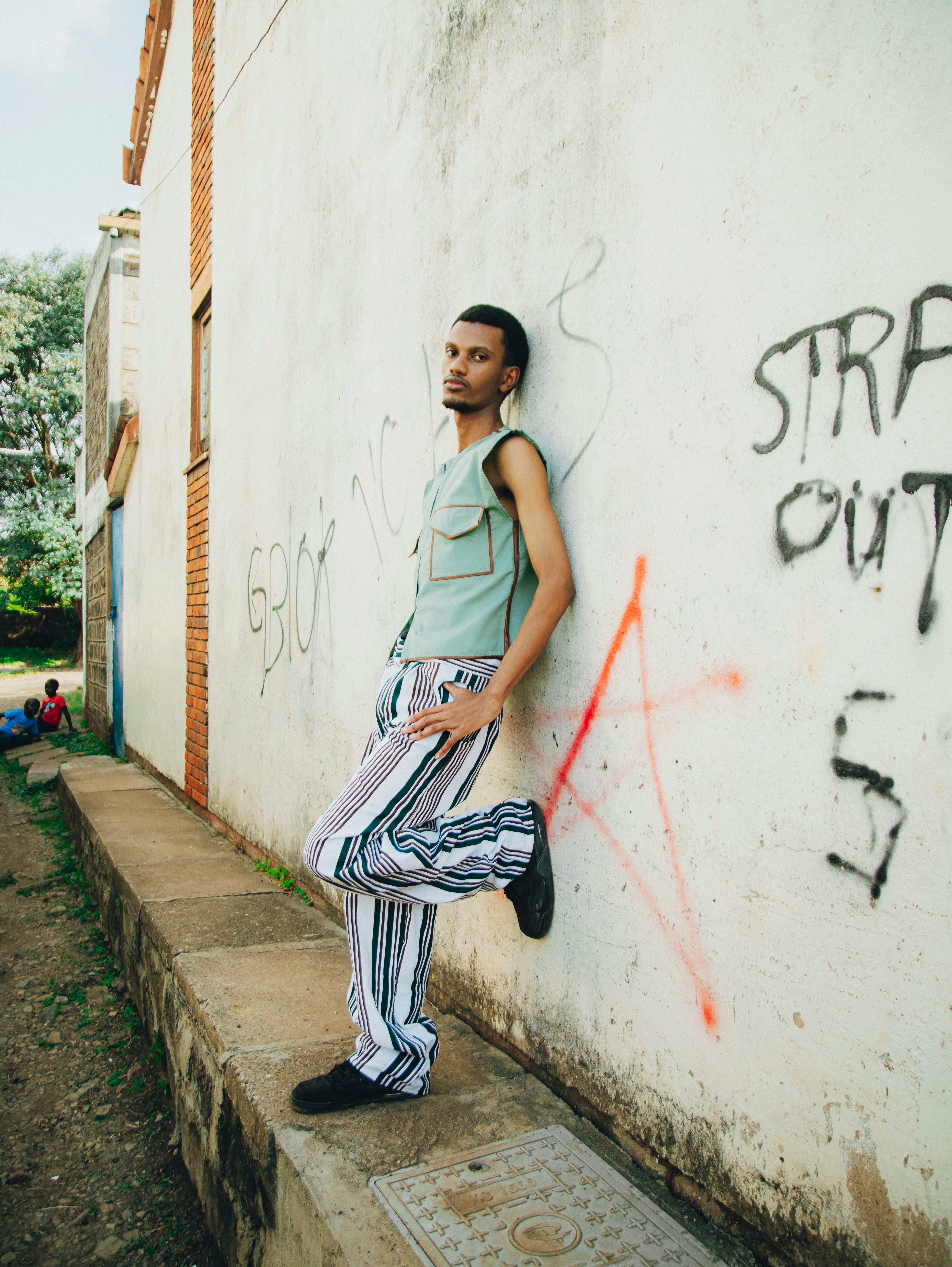 Lean Against the Wall: A Quiet Pose in Urban Graffiti Light