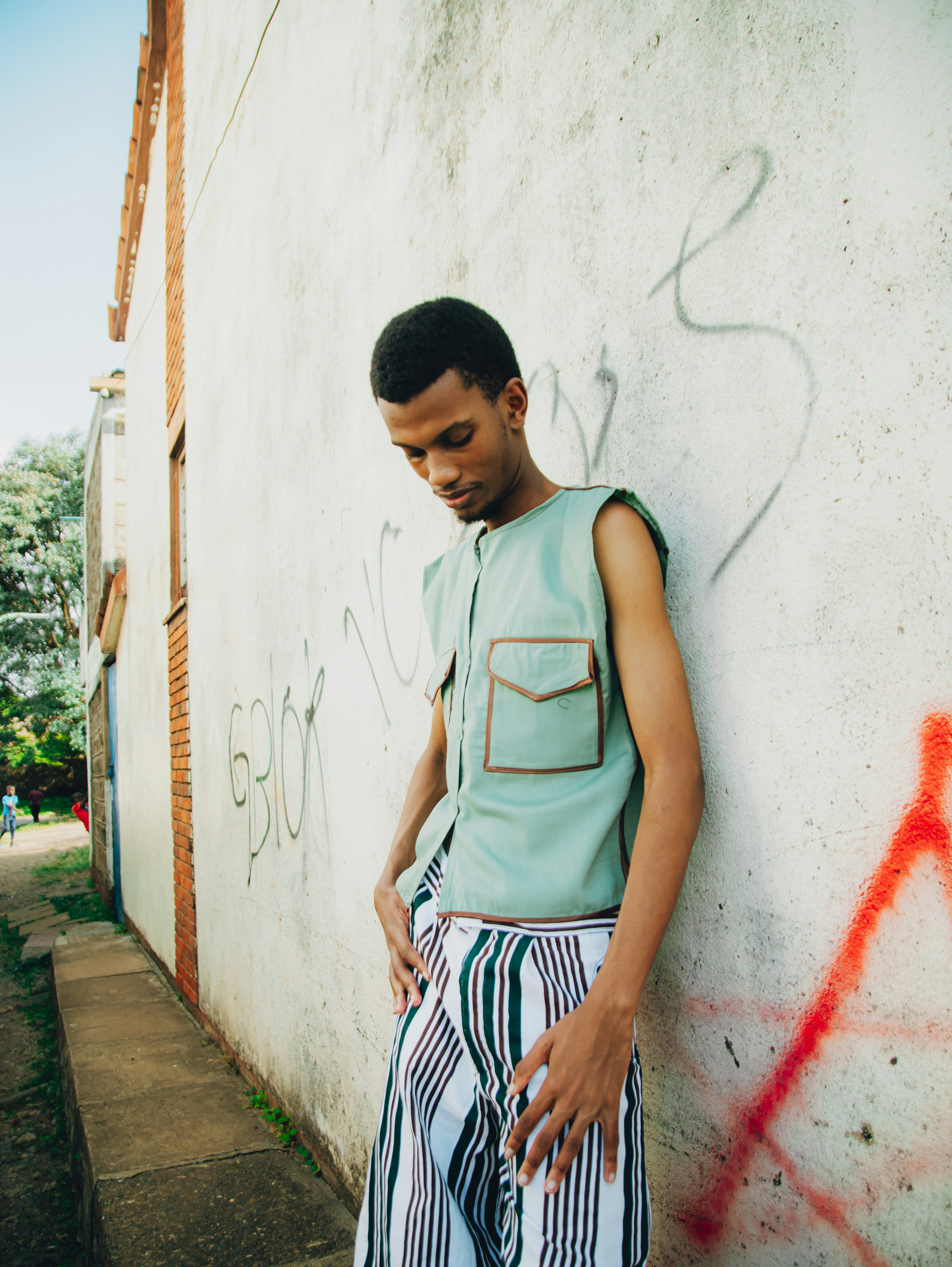 Lean Against the Wall: Quiet Confidence in a Sunlit Alley