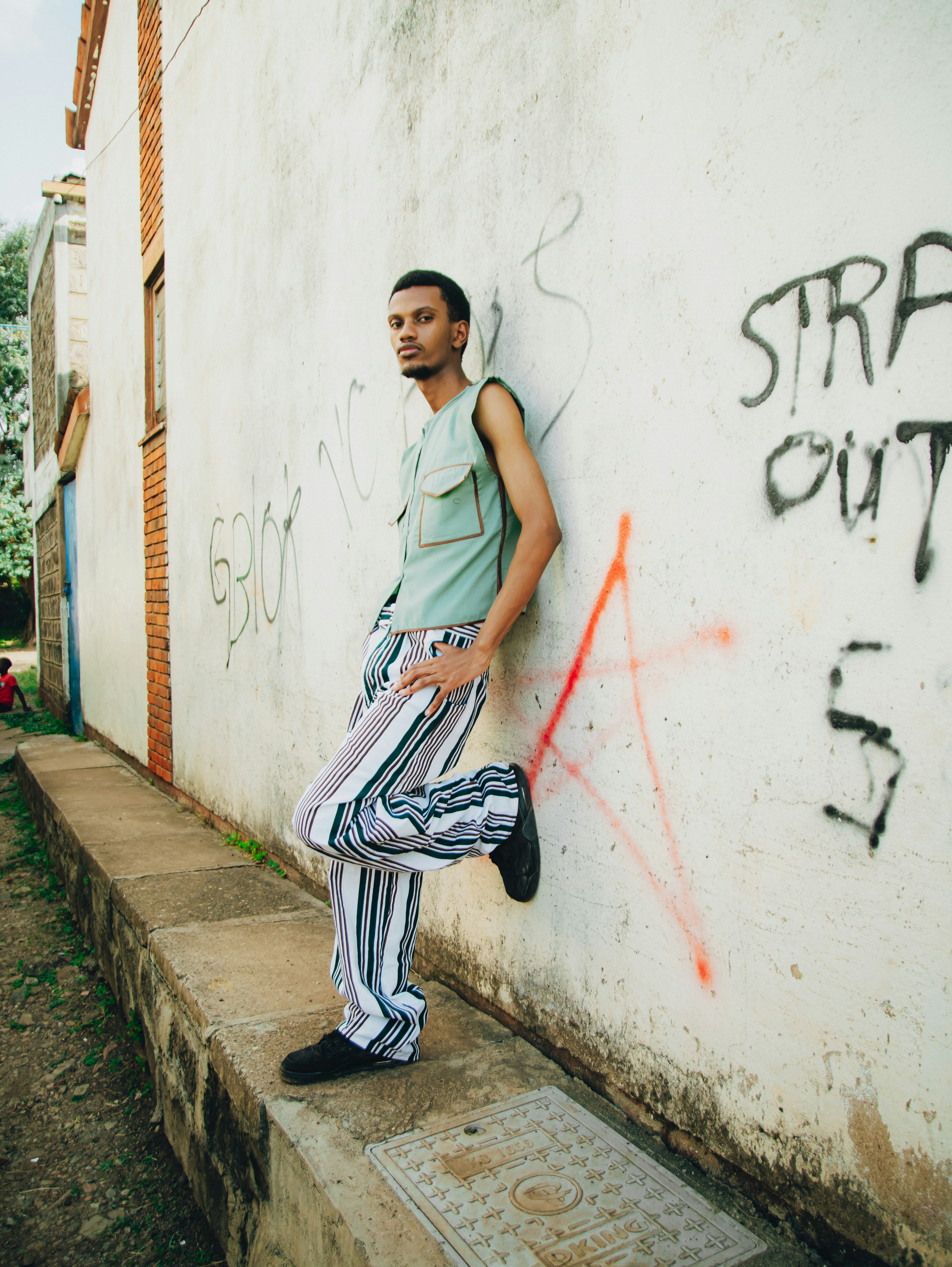 Leaning Against the Wall: A Street Portrait with Flowing Stripes