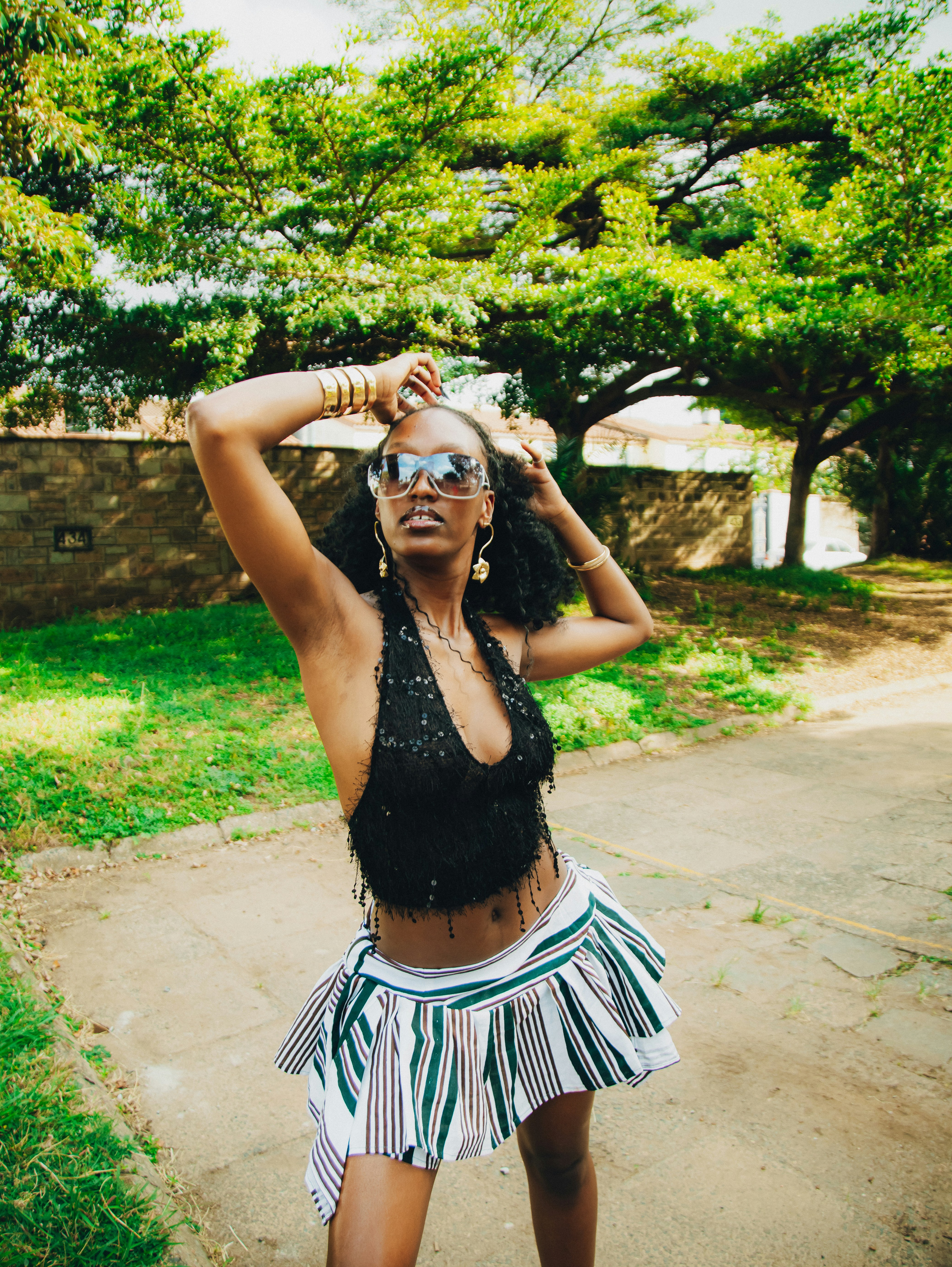 Sunlit Confidence: A Bold Summer Pose in the Shade