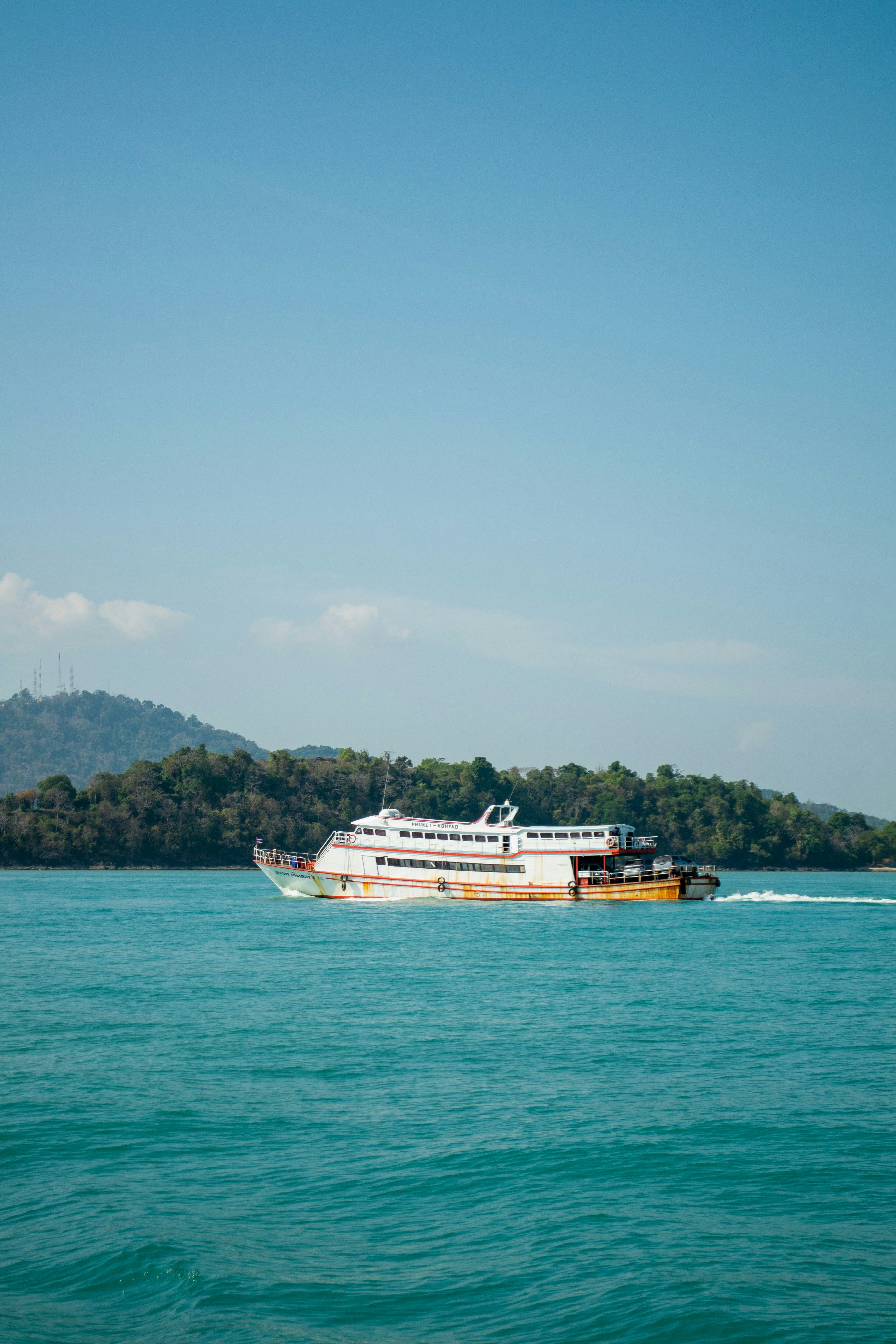 Azure Passage: A Boat Glides Past a Quiet Island