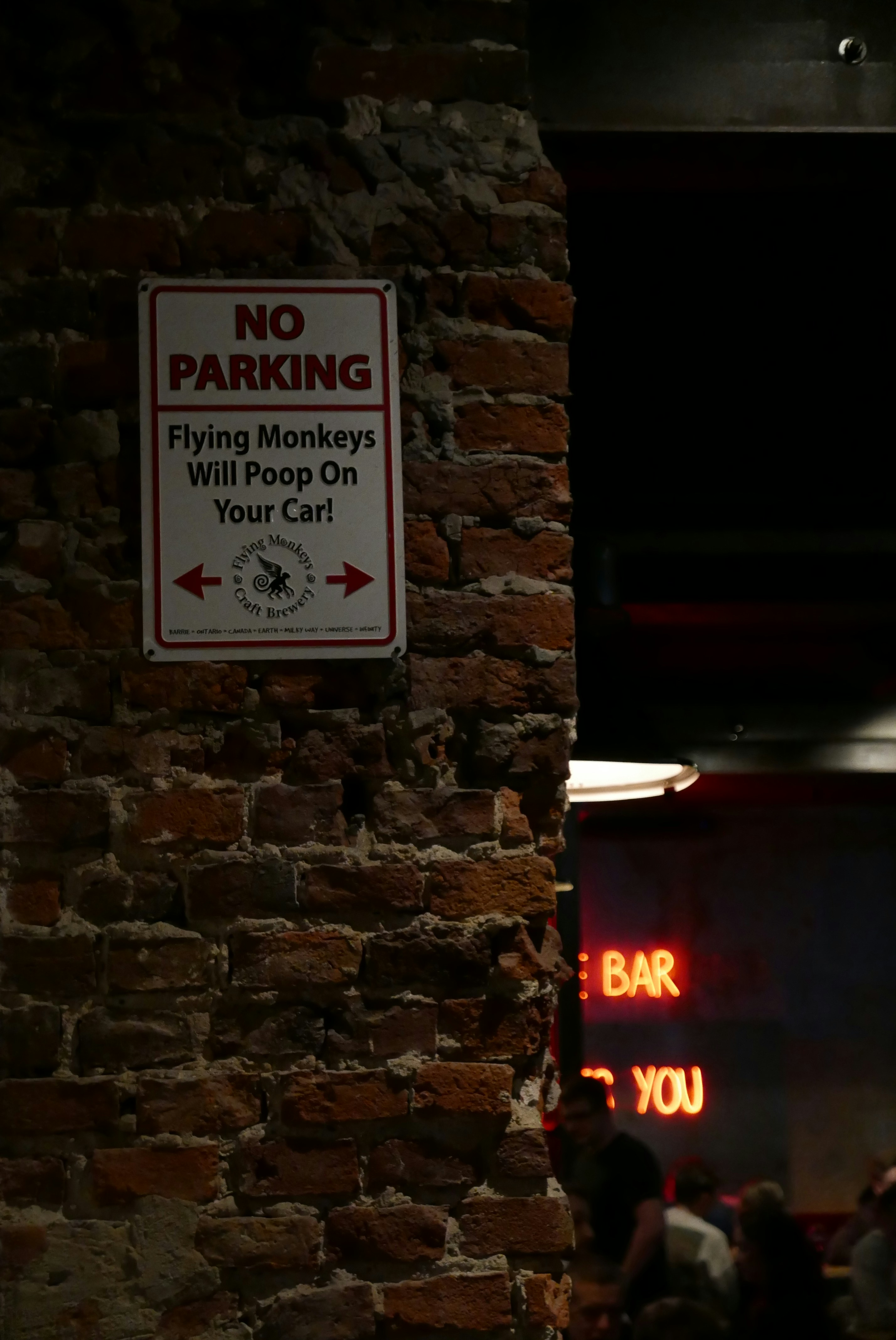 Brick Wall Signage and Neon Glow by the Bar