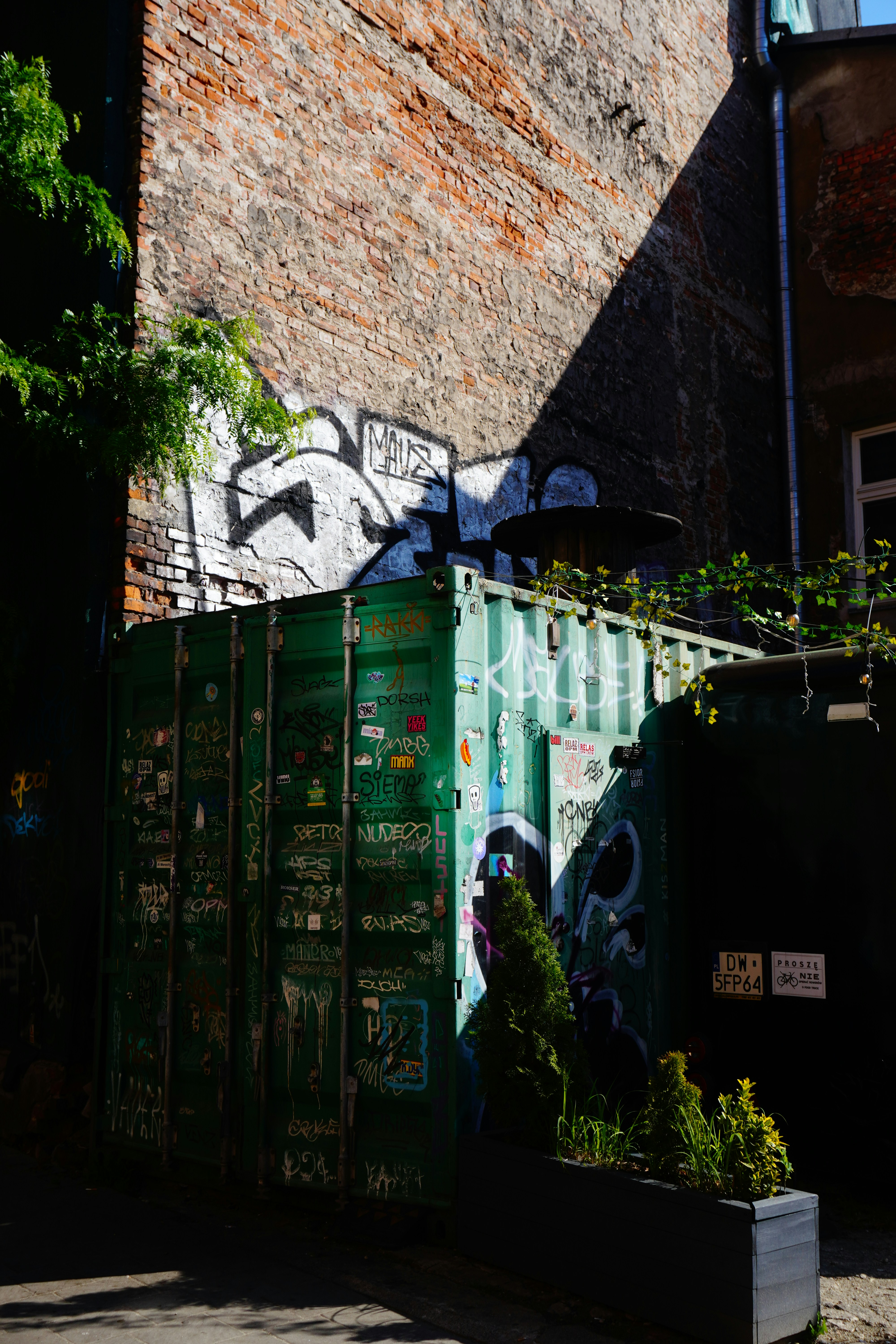 Graffiti-green Container Under Brick Archways