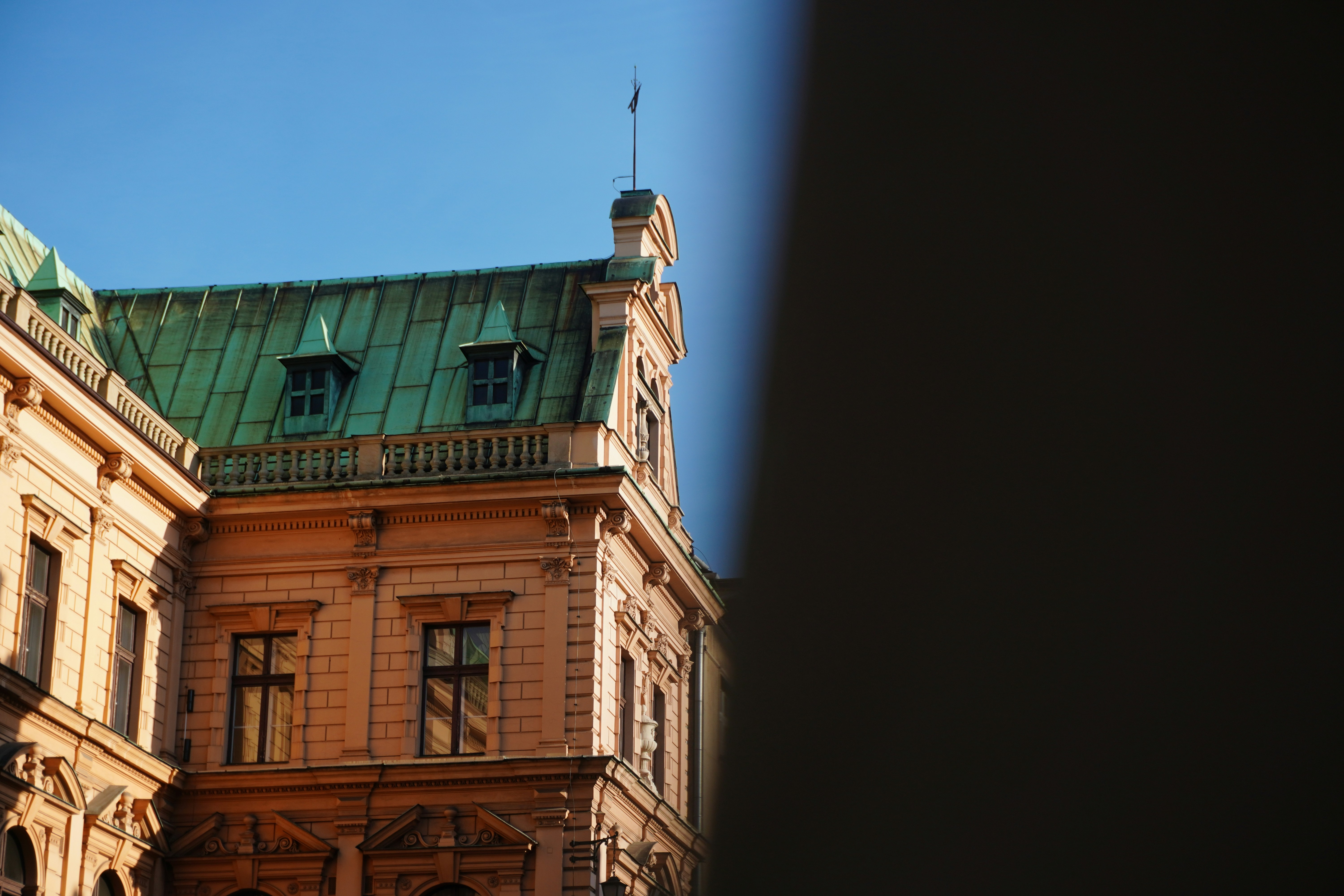 Sunlit Cornerstone: Historic Facade Emerges from the Shadow