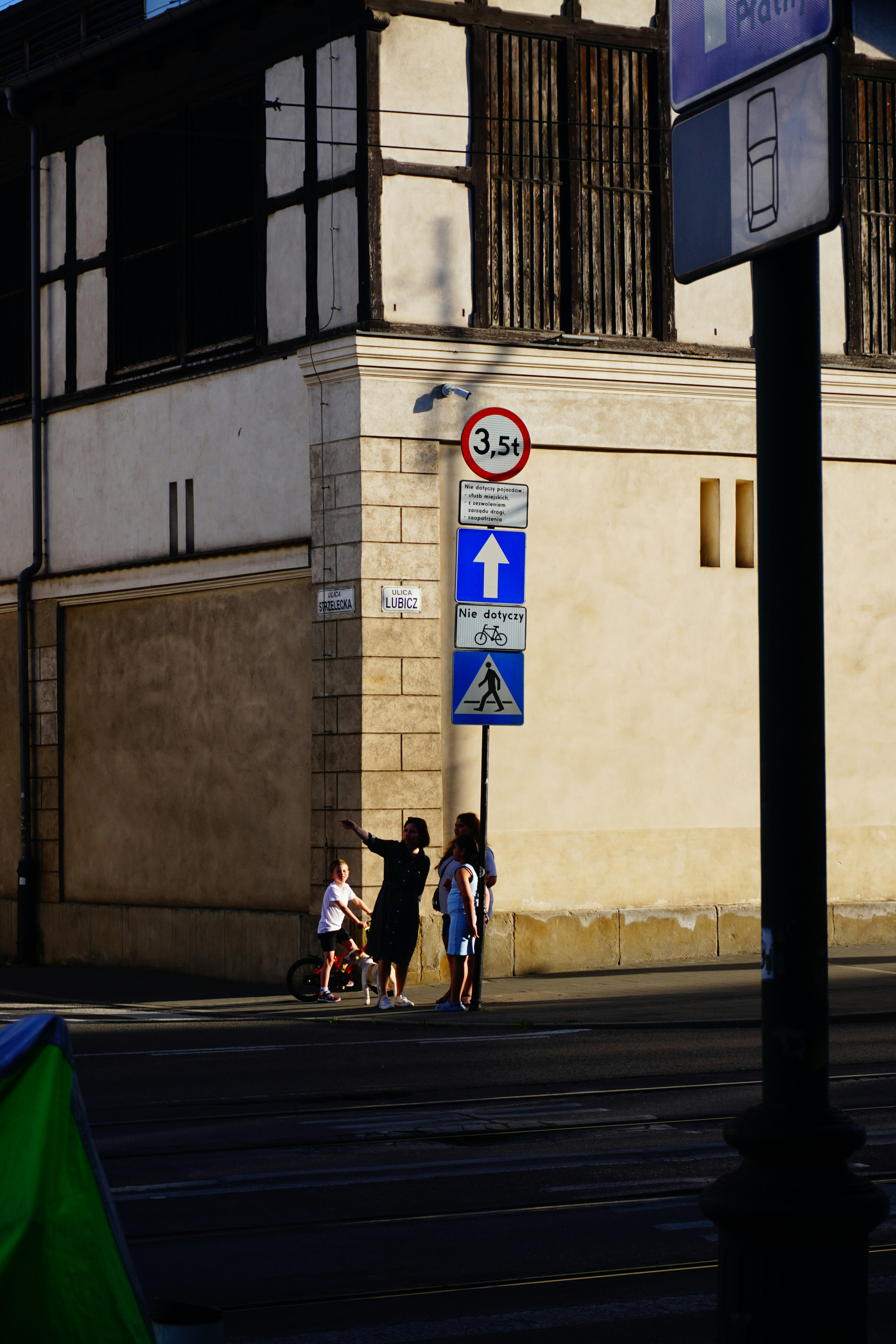 Urban Pedestrians at a Sunlit Street Corner