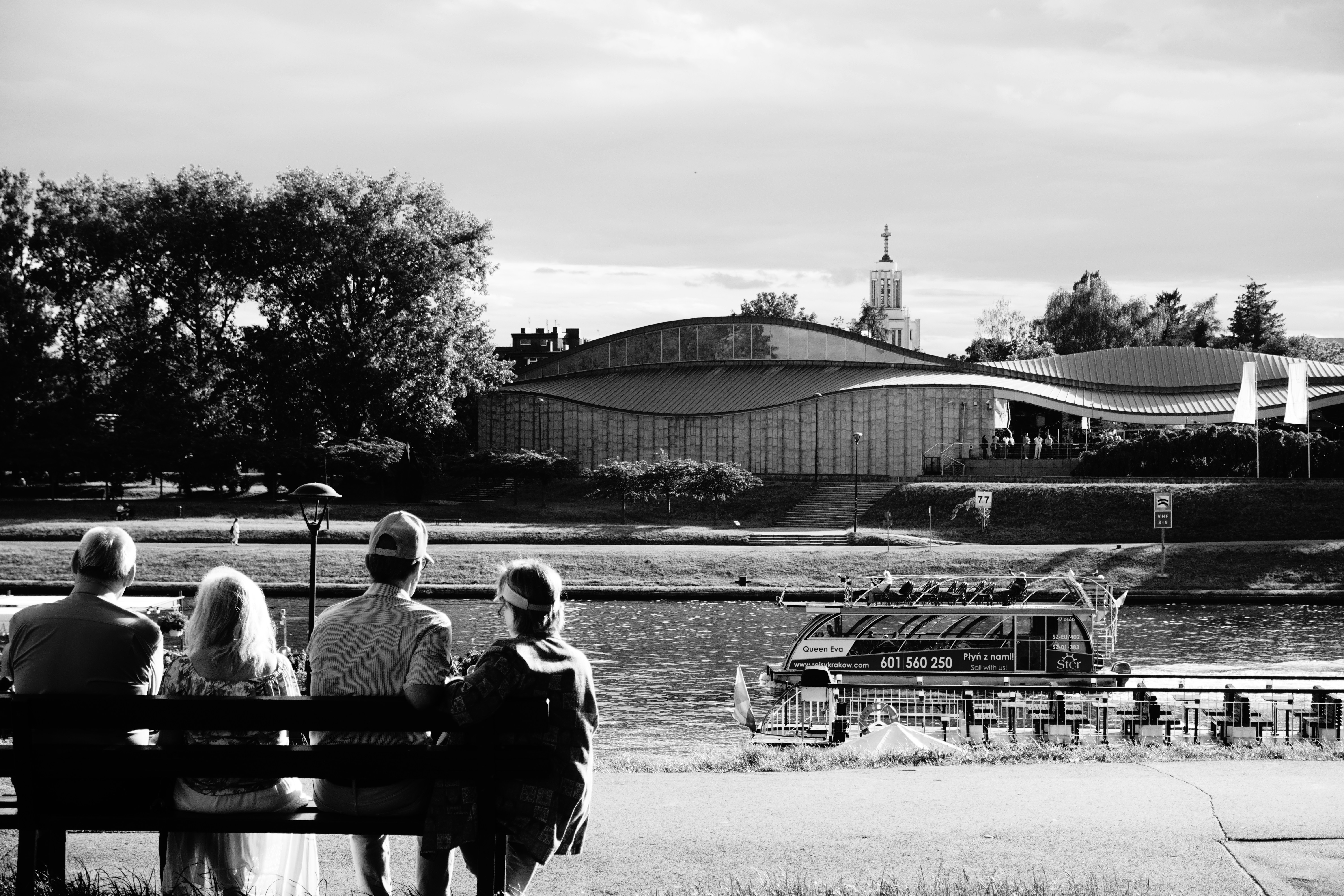 Backlit Riverside Audience: A City by the Water