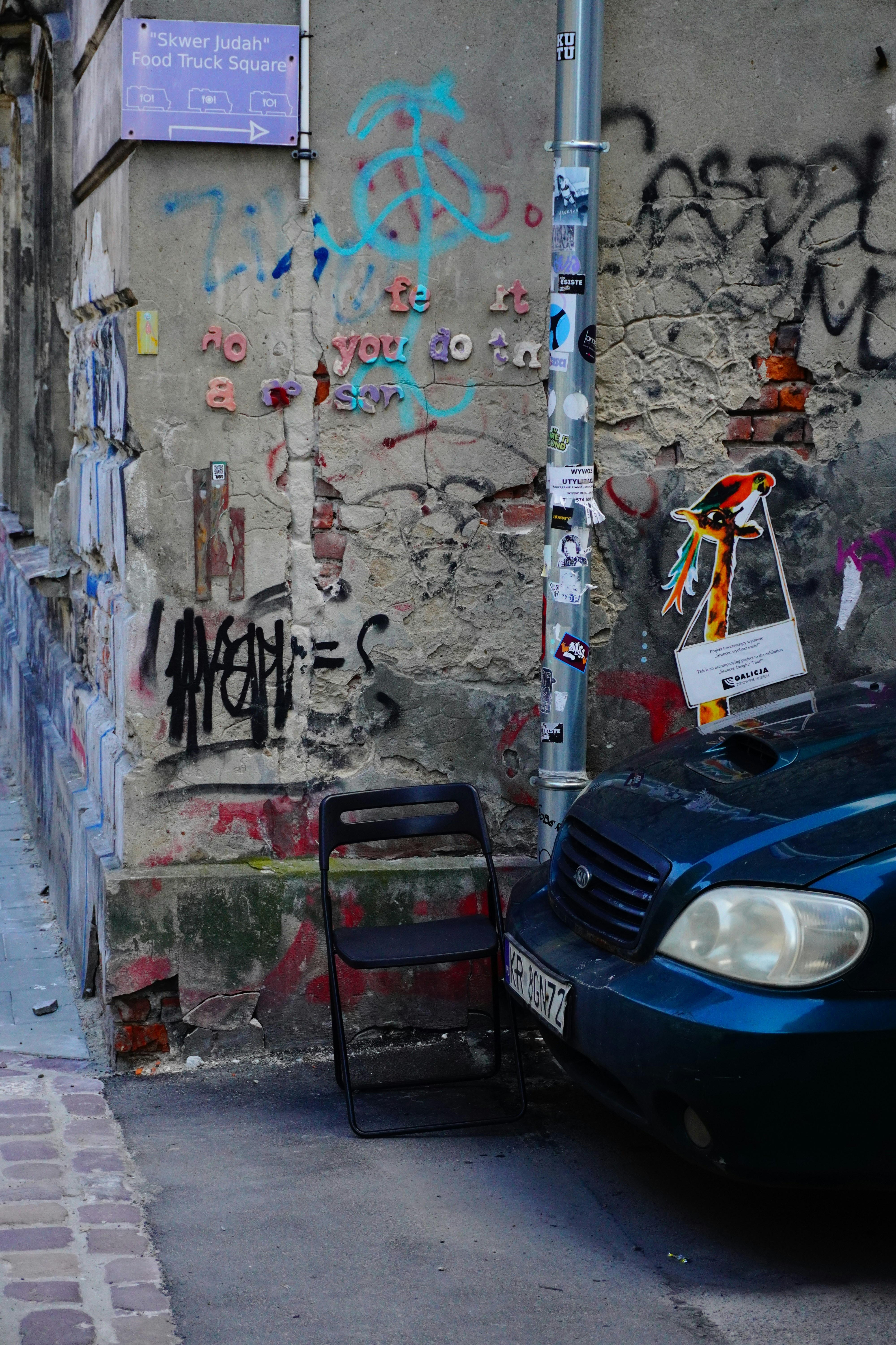 Urban Corner: Graffiti, Chair, and a Stalwart Taxi