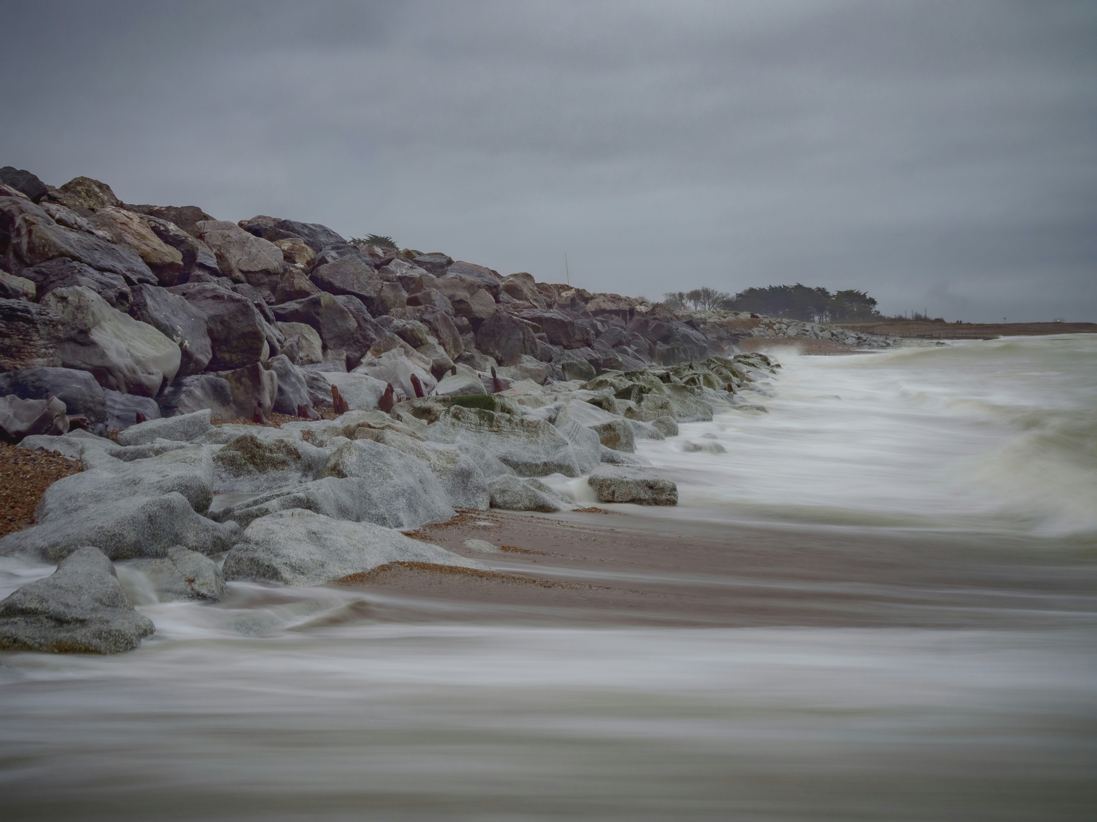 Rugged breakwater meeting a softening tide