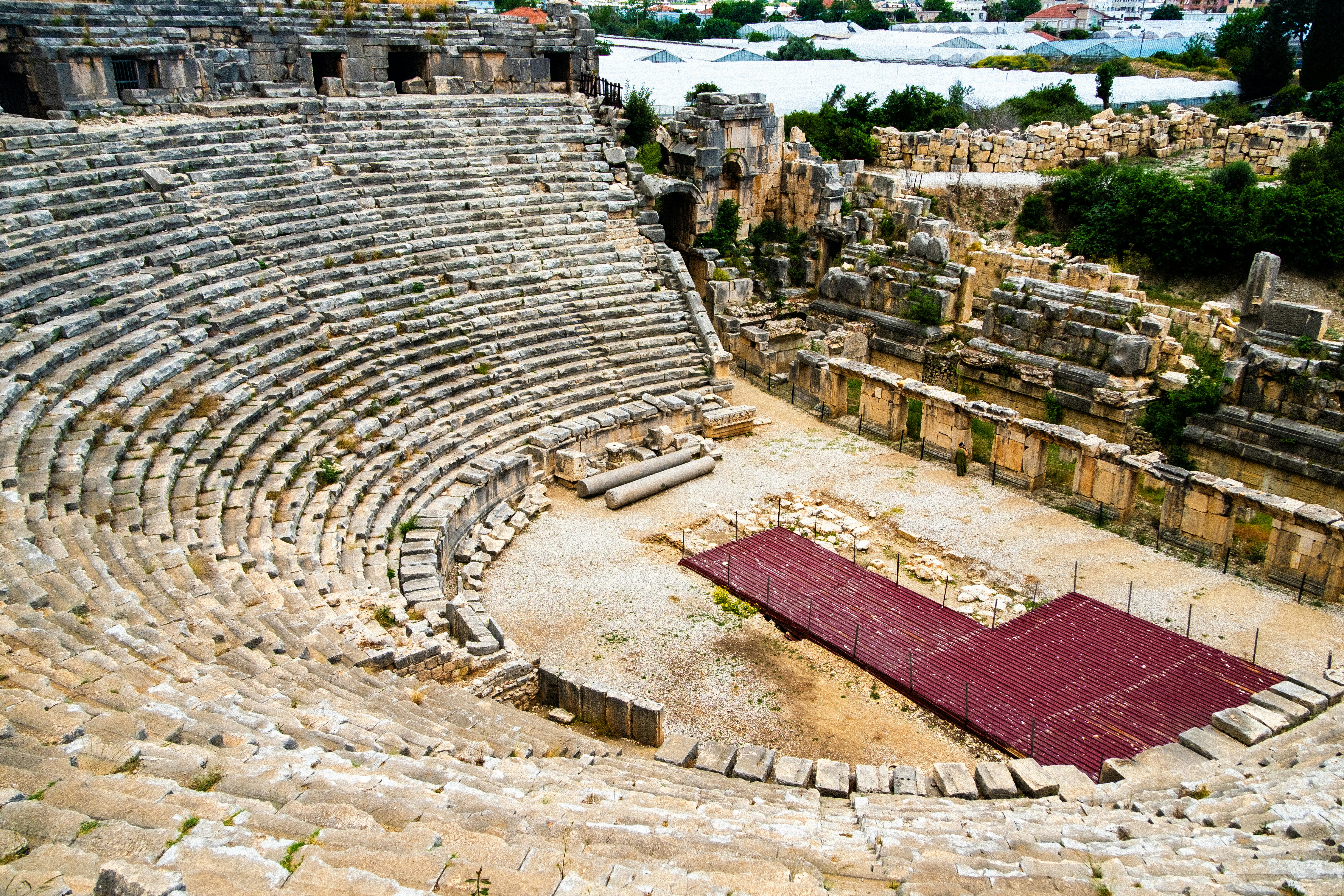 Stone Amphitheater Echoes: A sunlit ruin nestled in steps and shadows