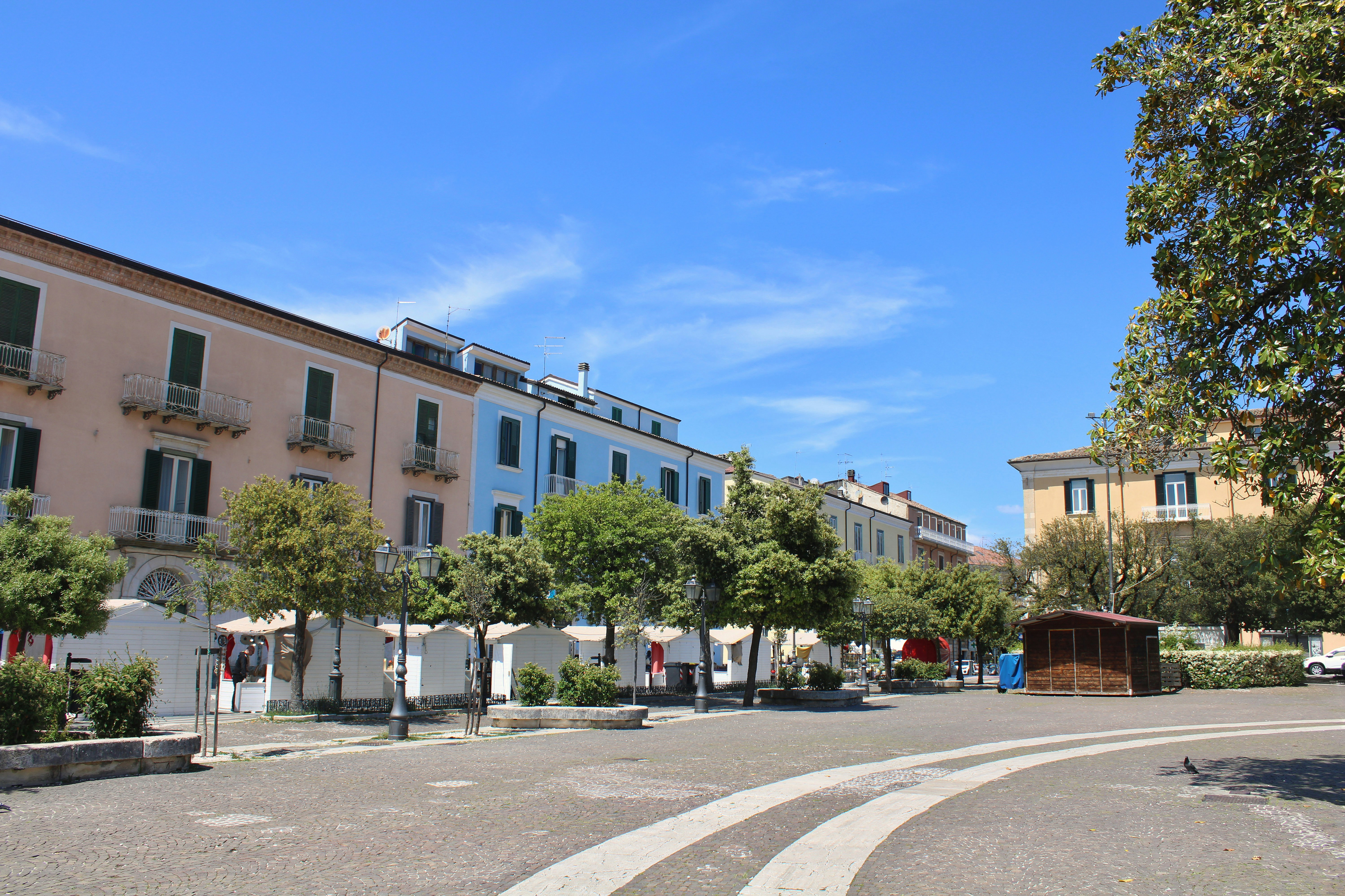 Sunlit Town Square with Colorful Facades and Arcades