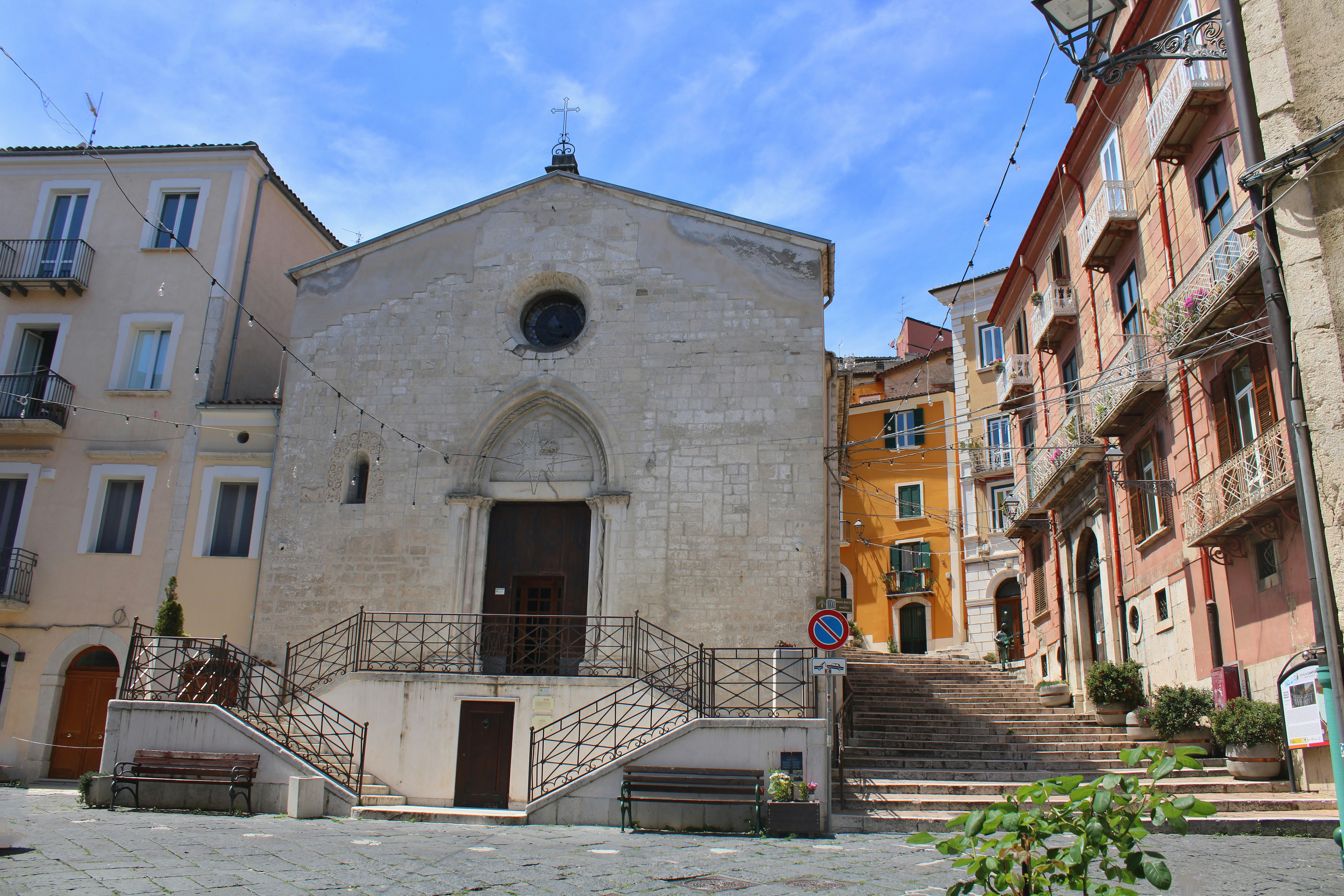Stone Church at the Crest: A Quiet Piazza Between Colorful Stairways