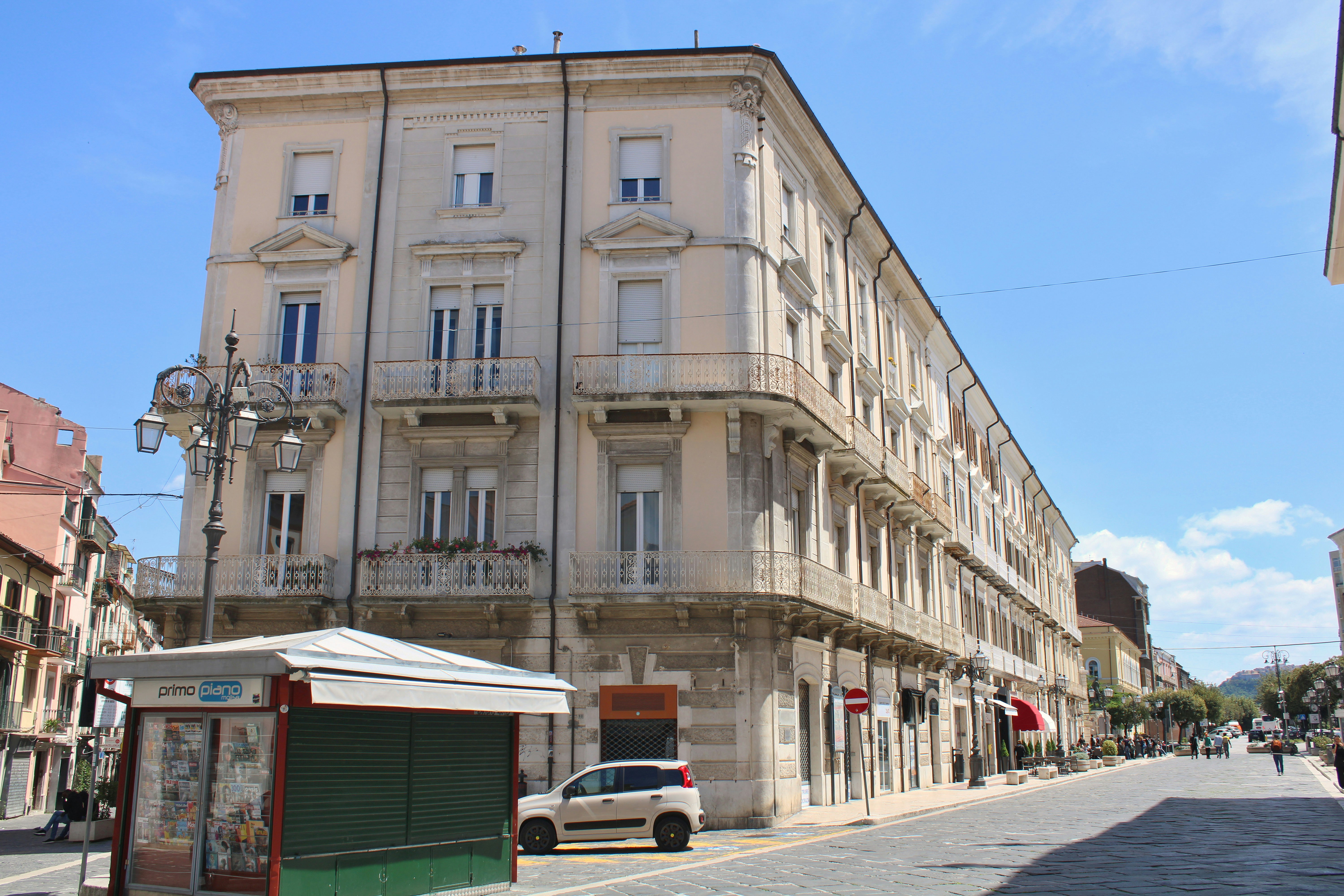 White-walled Cornered Facade on a Busy Mediterranean Street