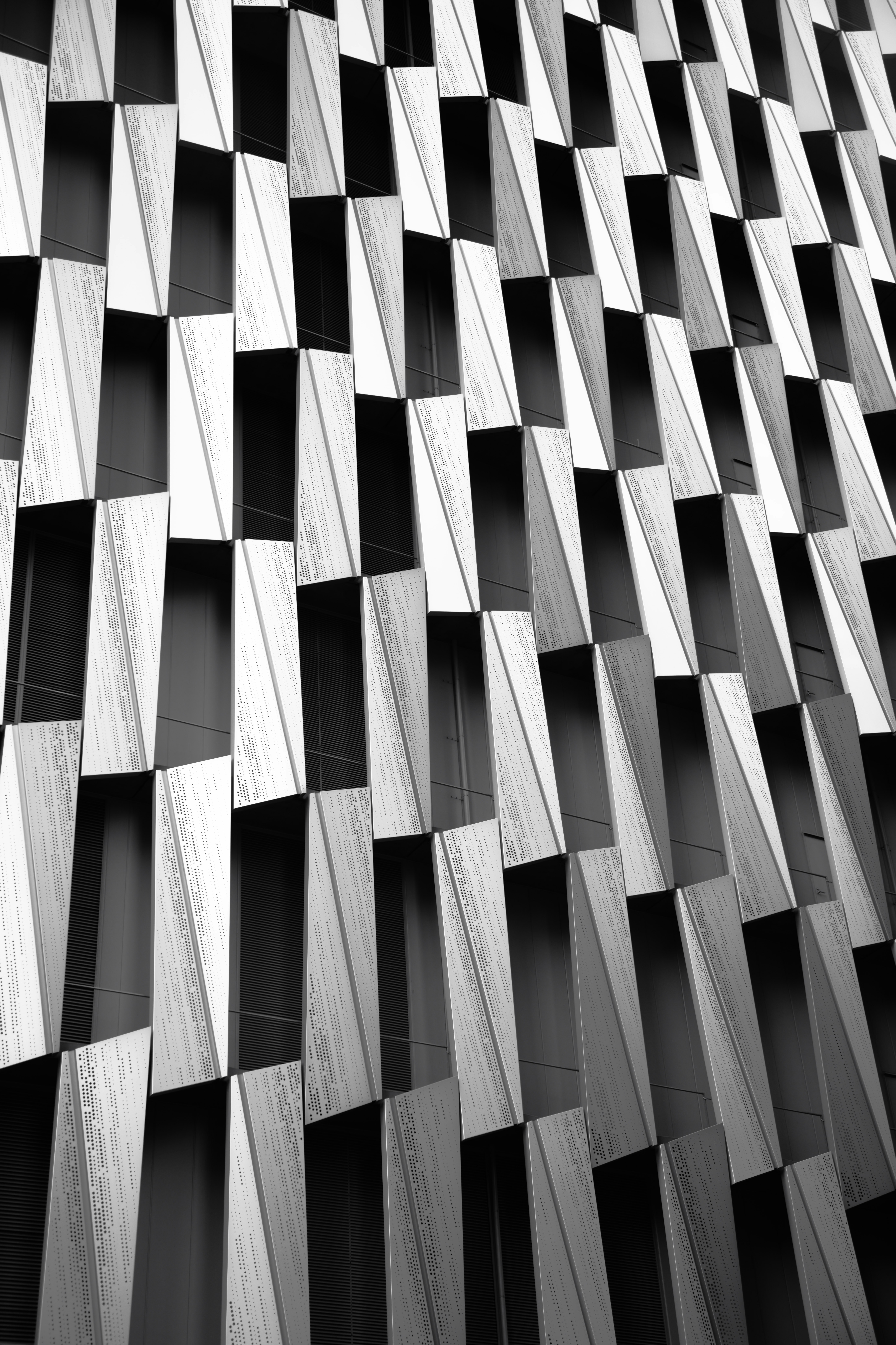 Chevron Facade: A Rhythmic Play of Light on Angled Aluminum Panels