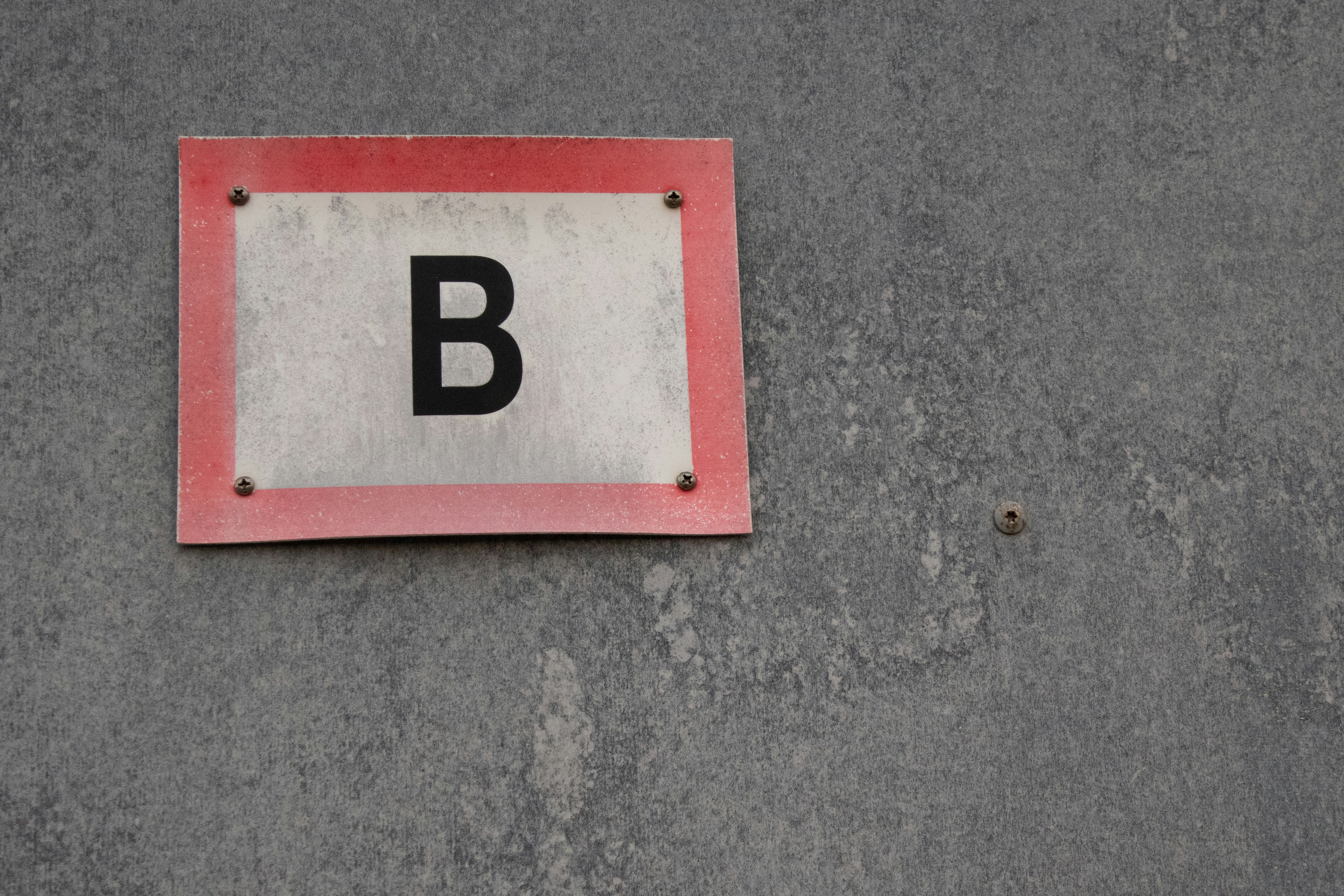 Letter B on a Weathered Concrete Plate