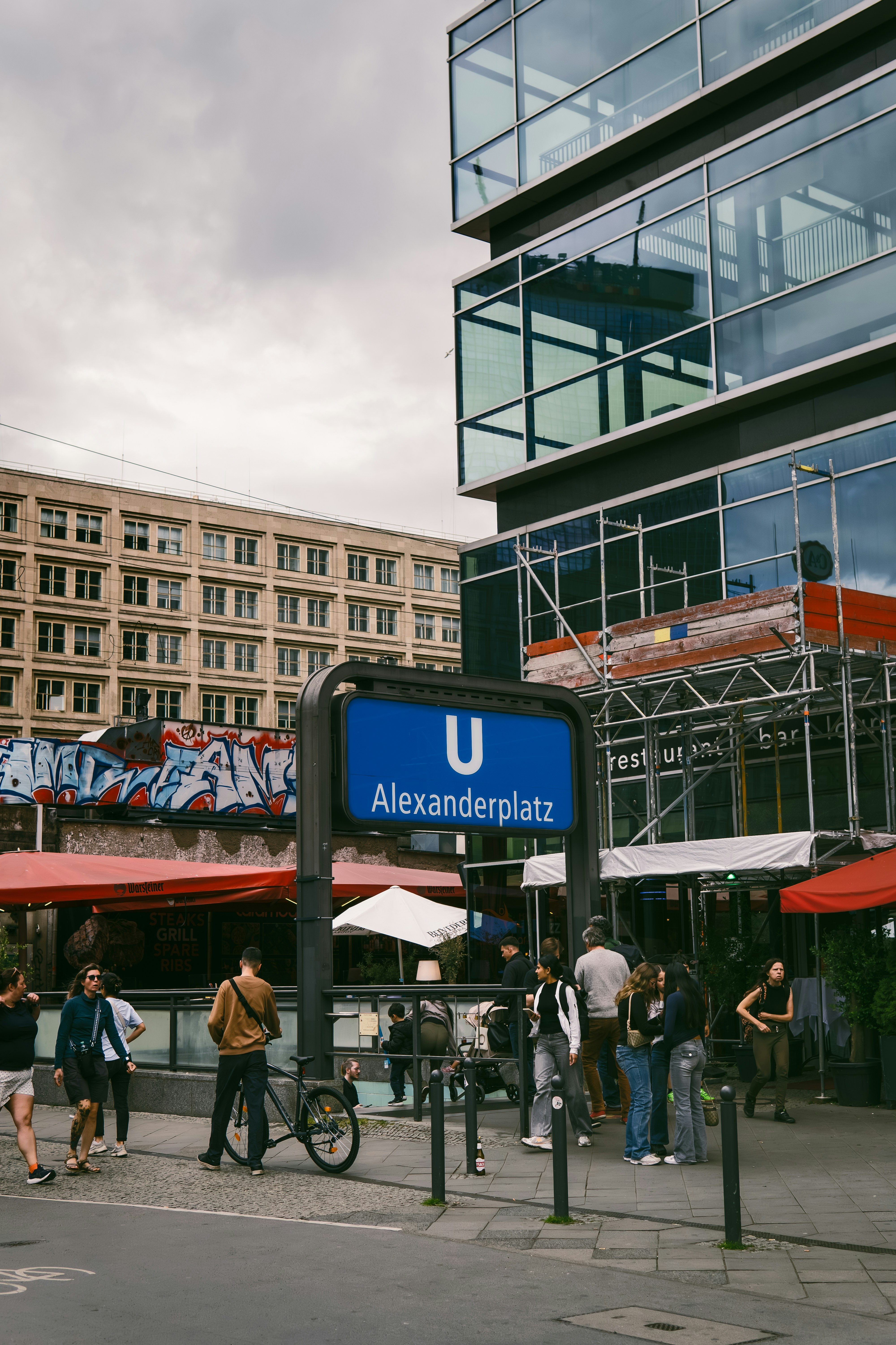 Urban Crossing: The Alexanderplatz Signal Amid Glass and Graffiti