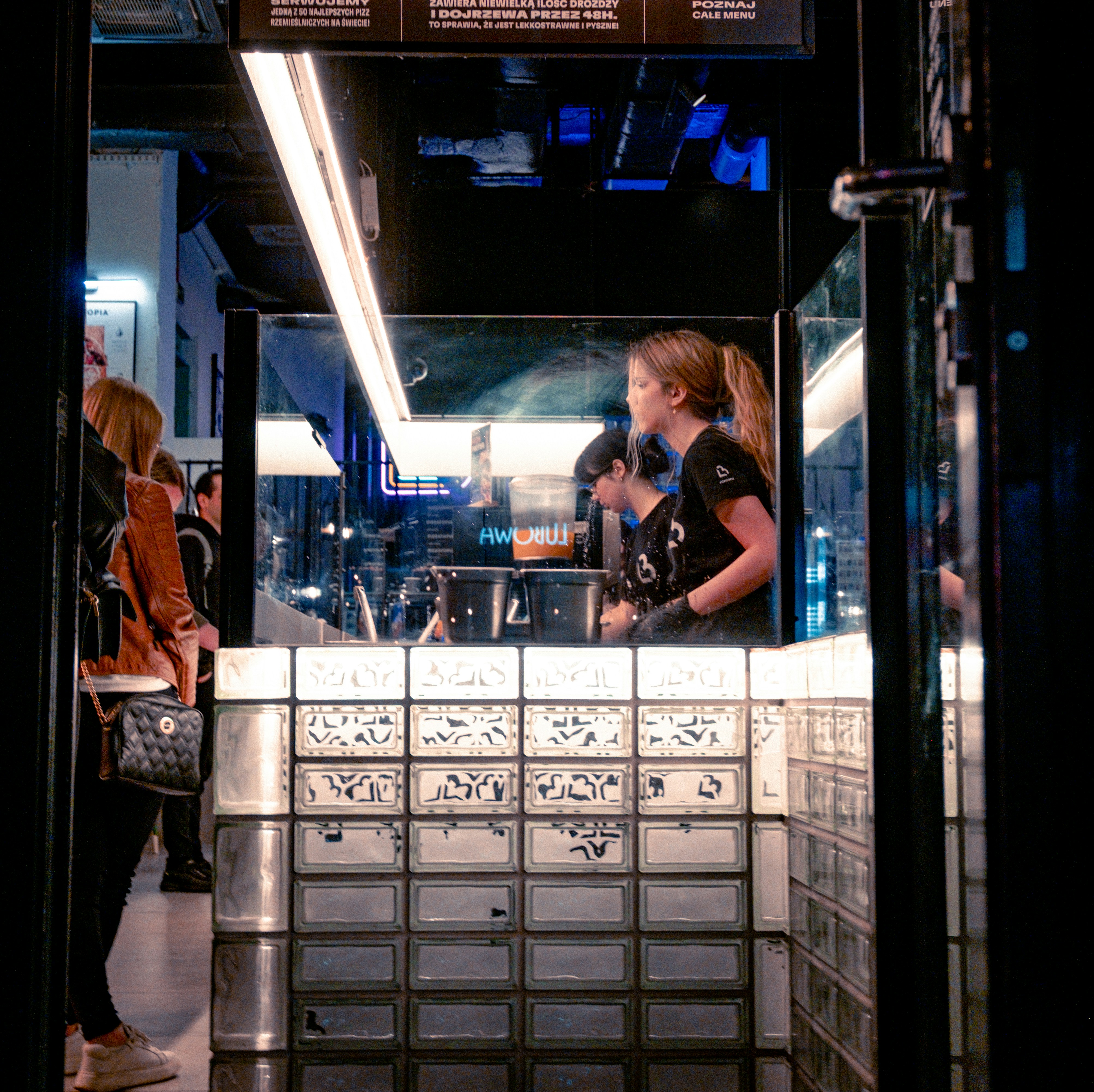 Behind the Counter: Reflections and Neon in a Modern Barrierscape