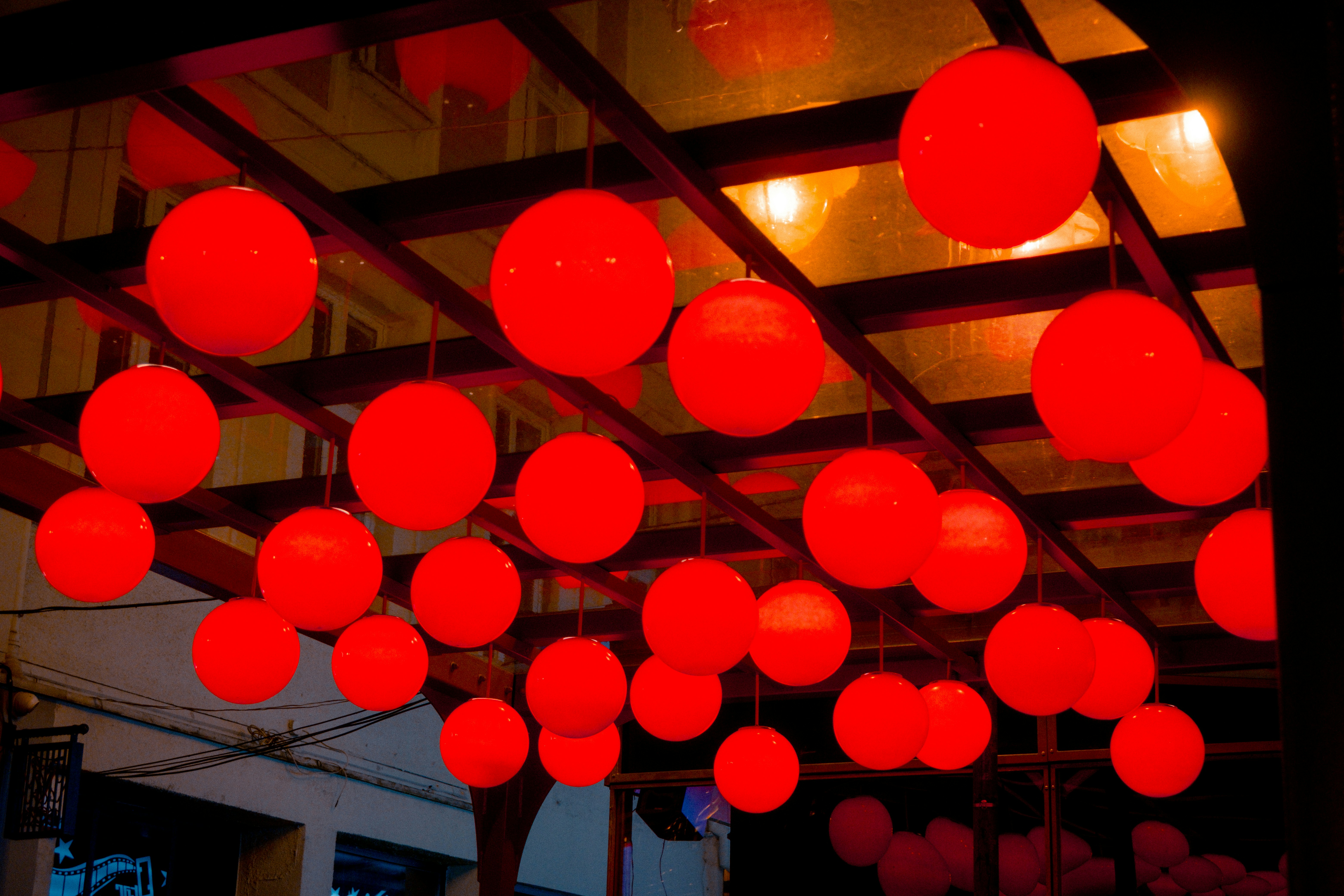 Red Lantern canopy: a sea of orbs under steel beams