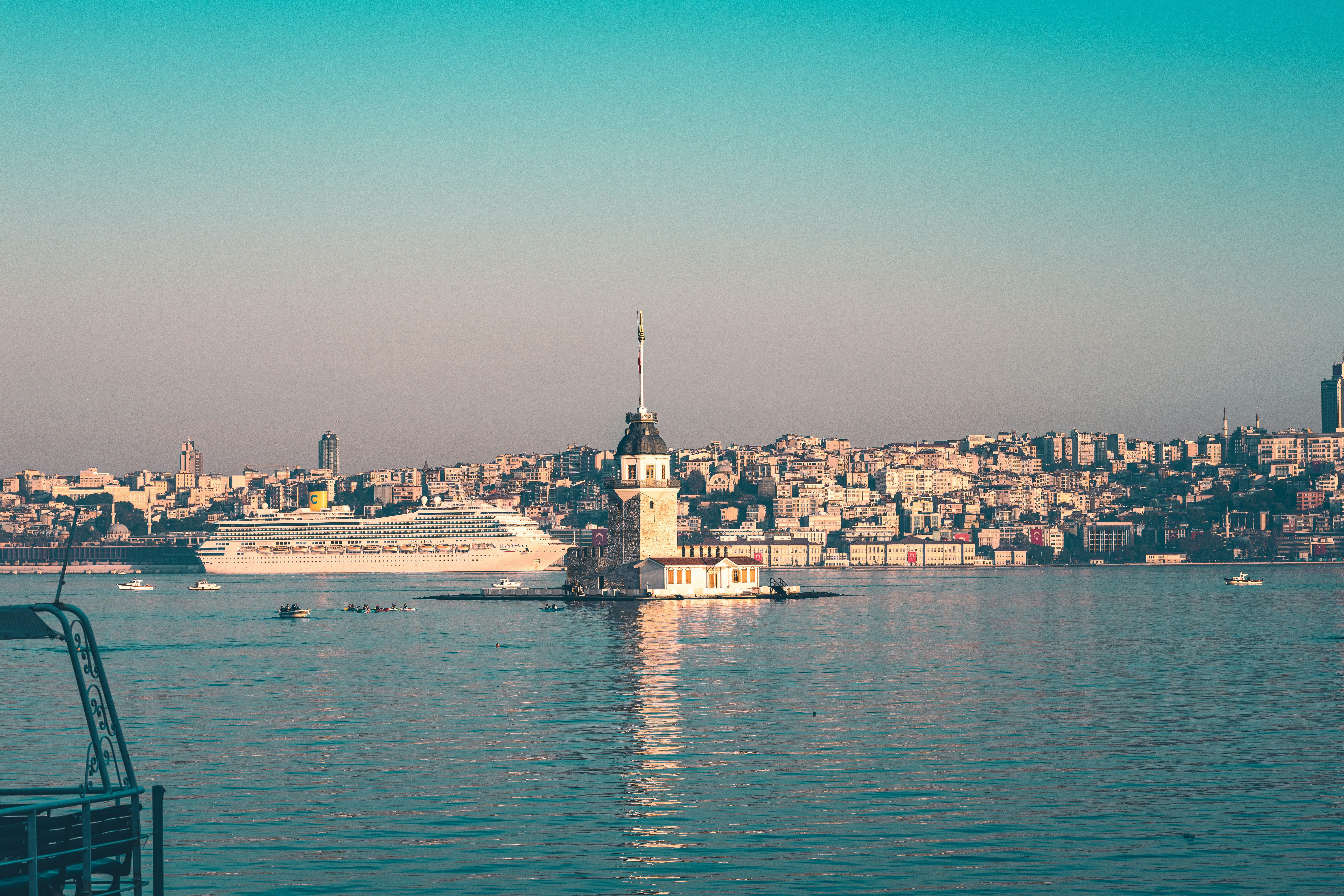 Island Lighthouse Stands Guard Over Calm Urban Wake