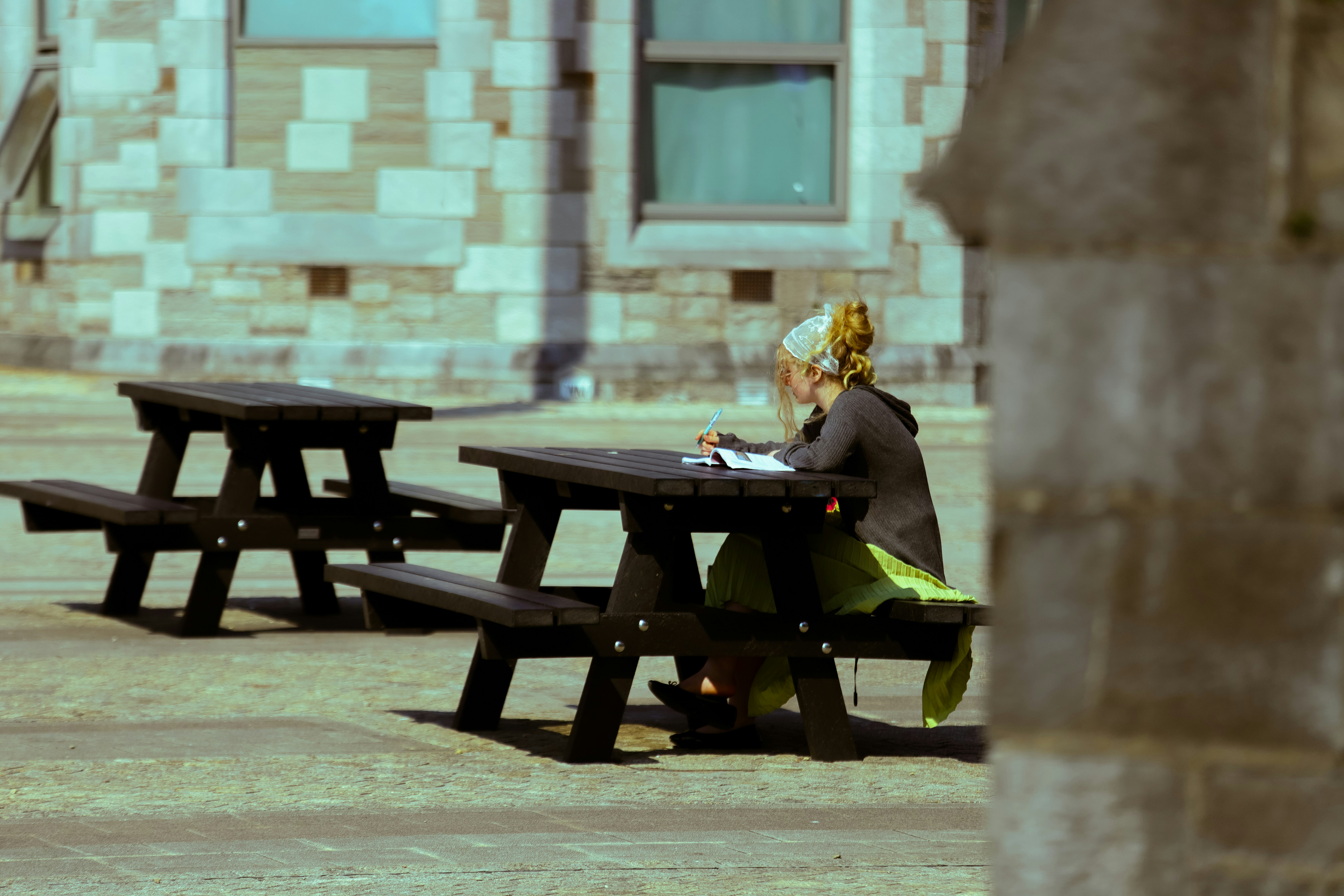 Quiet Study under the Parkside Sky: a student at a distant table