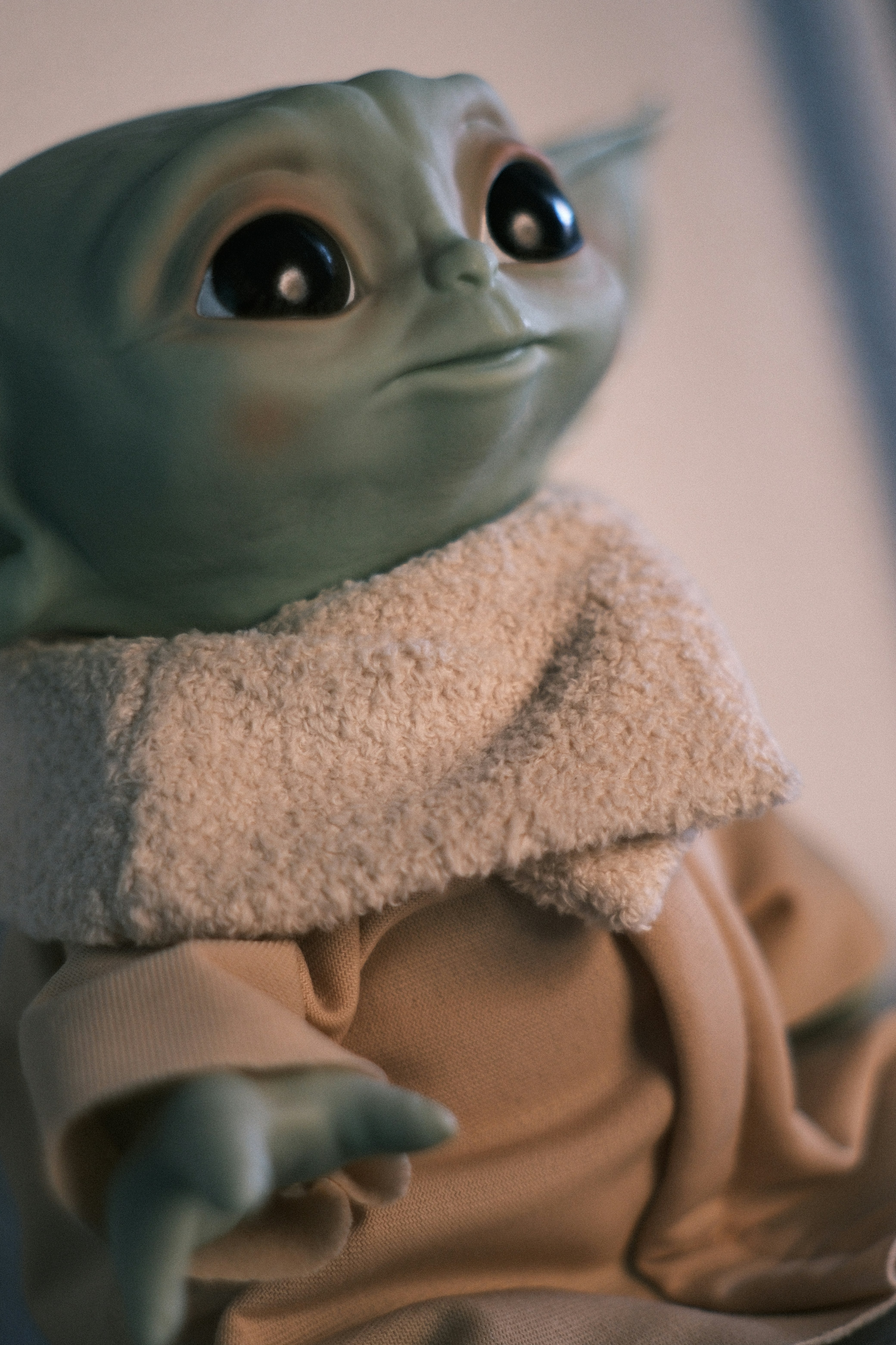 Grogu figure in a light brown robe.