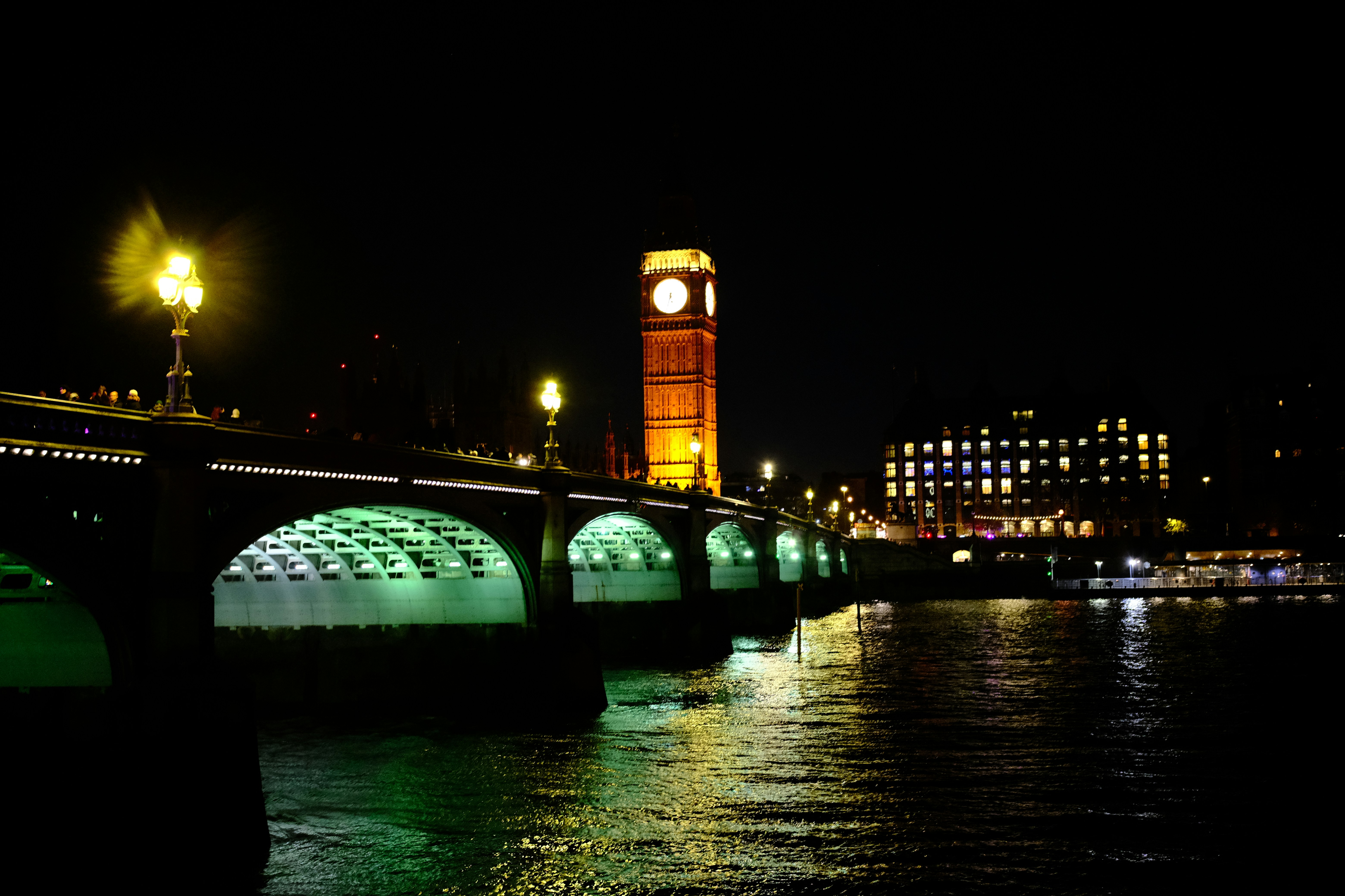 London by Night: Clock Tower and Green-Illuminated Bridge Across the Thames