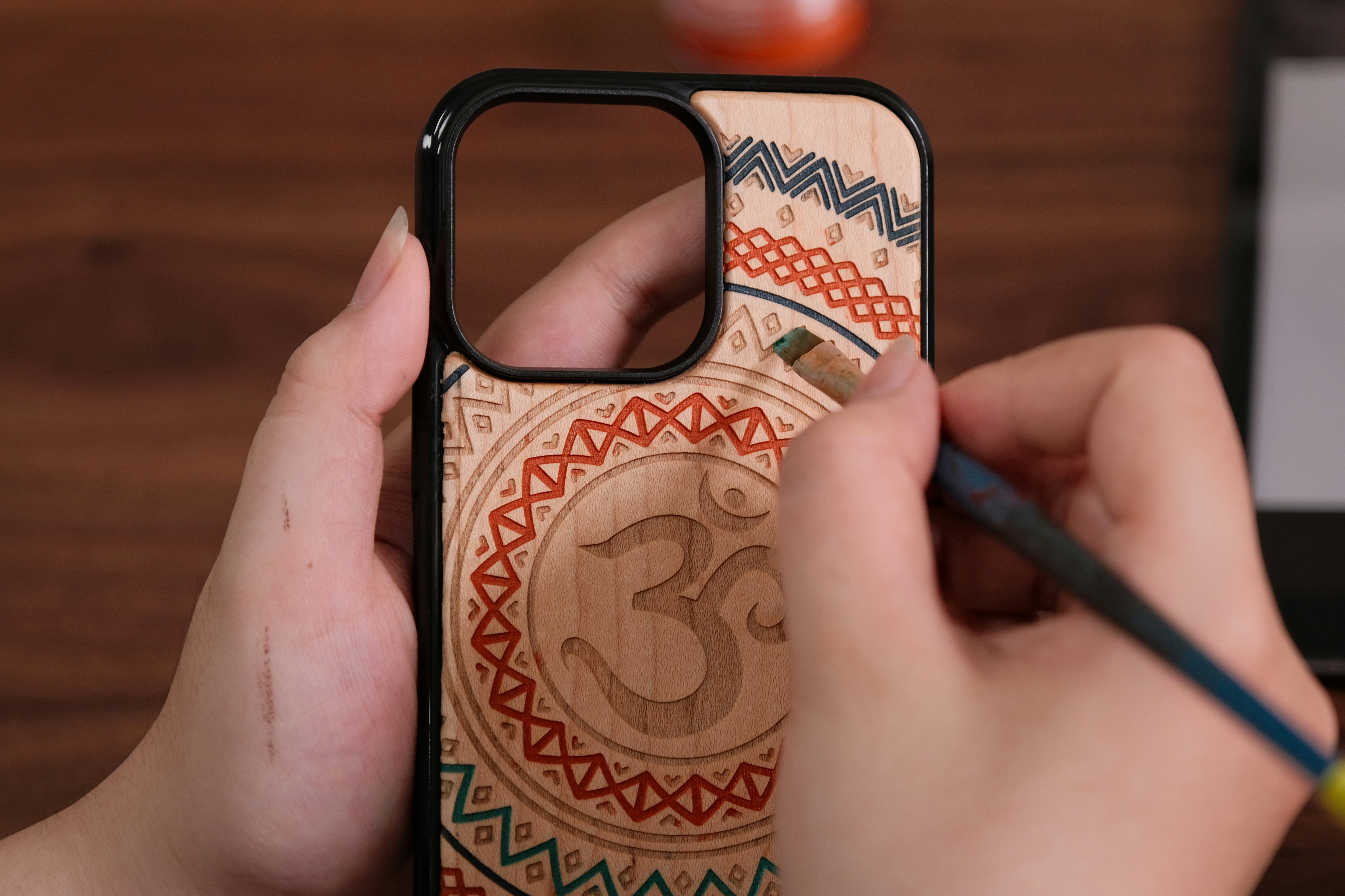 Carved Om Symbol On Wooden Phone Case Under Precision Pencil Strokes