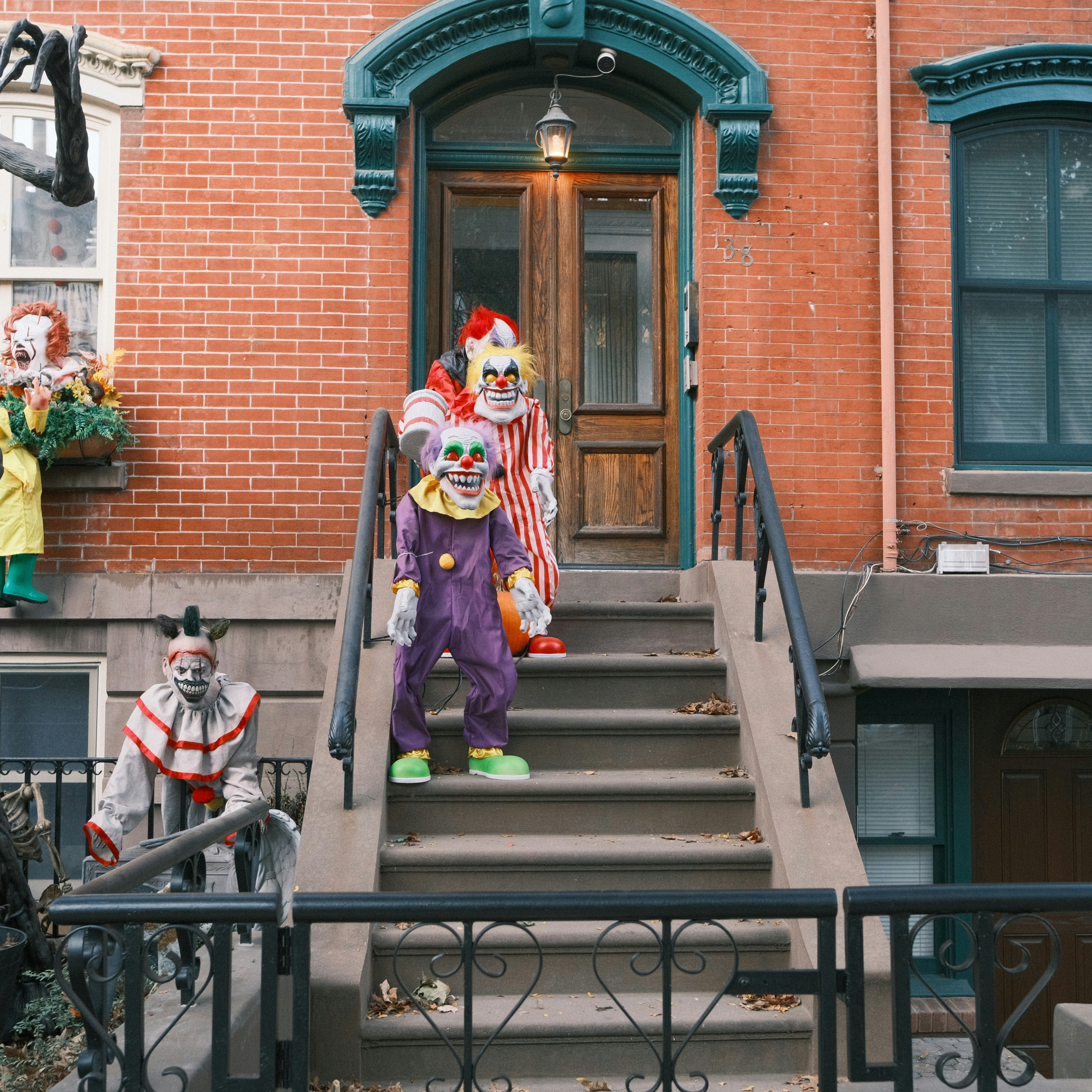 Clowning Up the Steps: A Row of Festive Figures Guarding the Brick Entrance