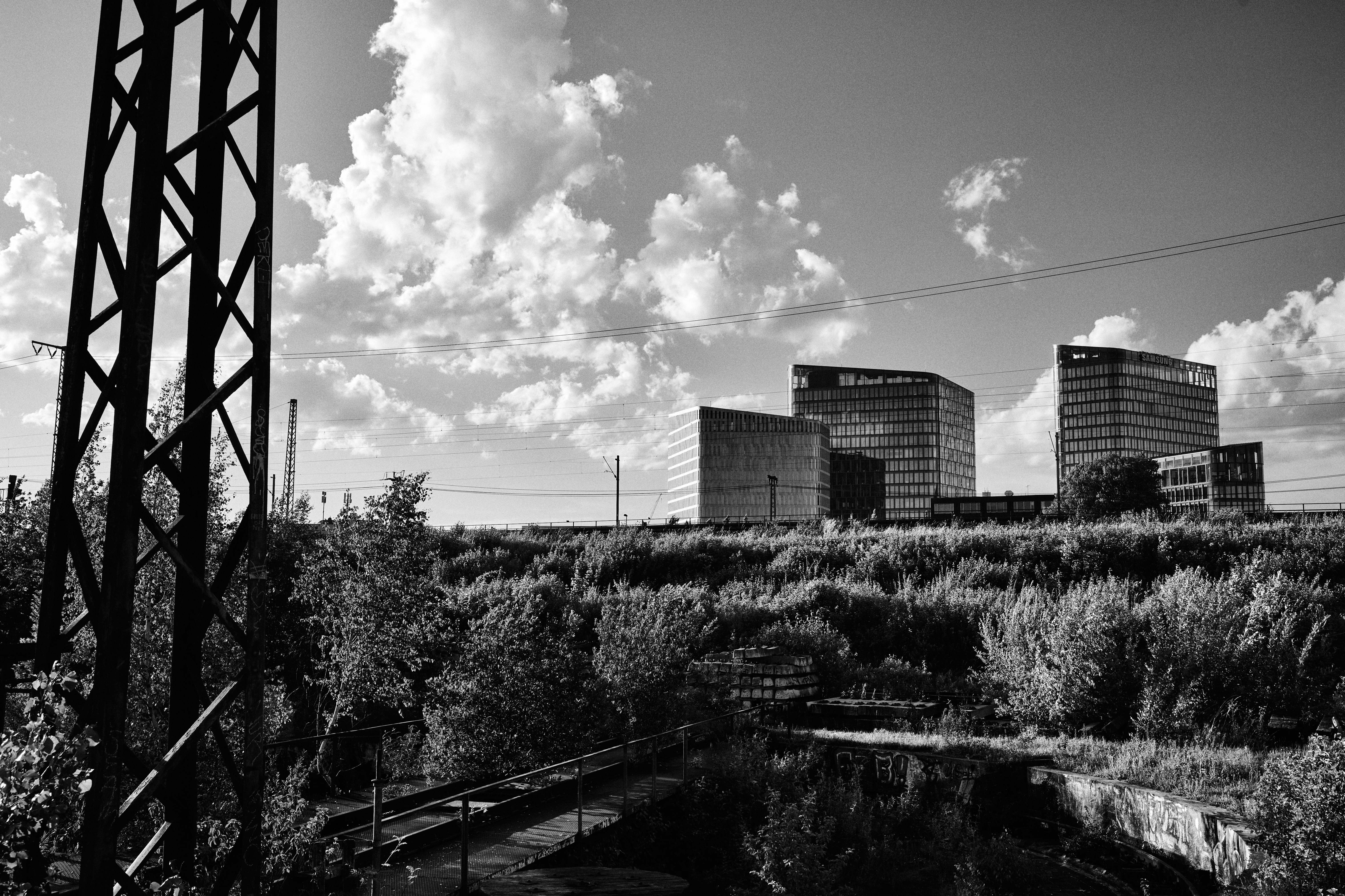Industrial silhouettes under a cloud-strewn sky