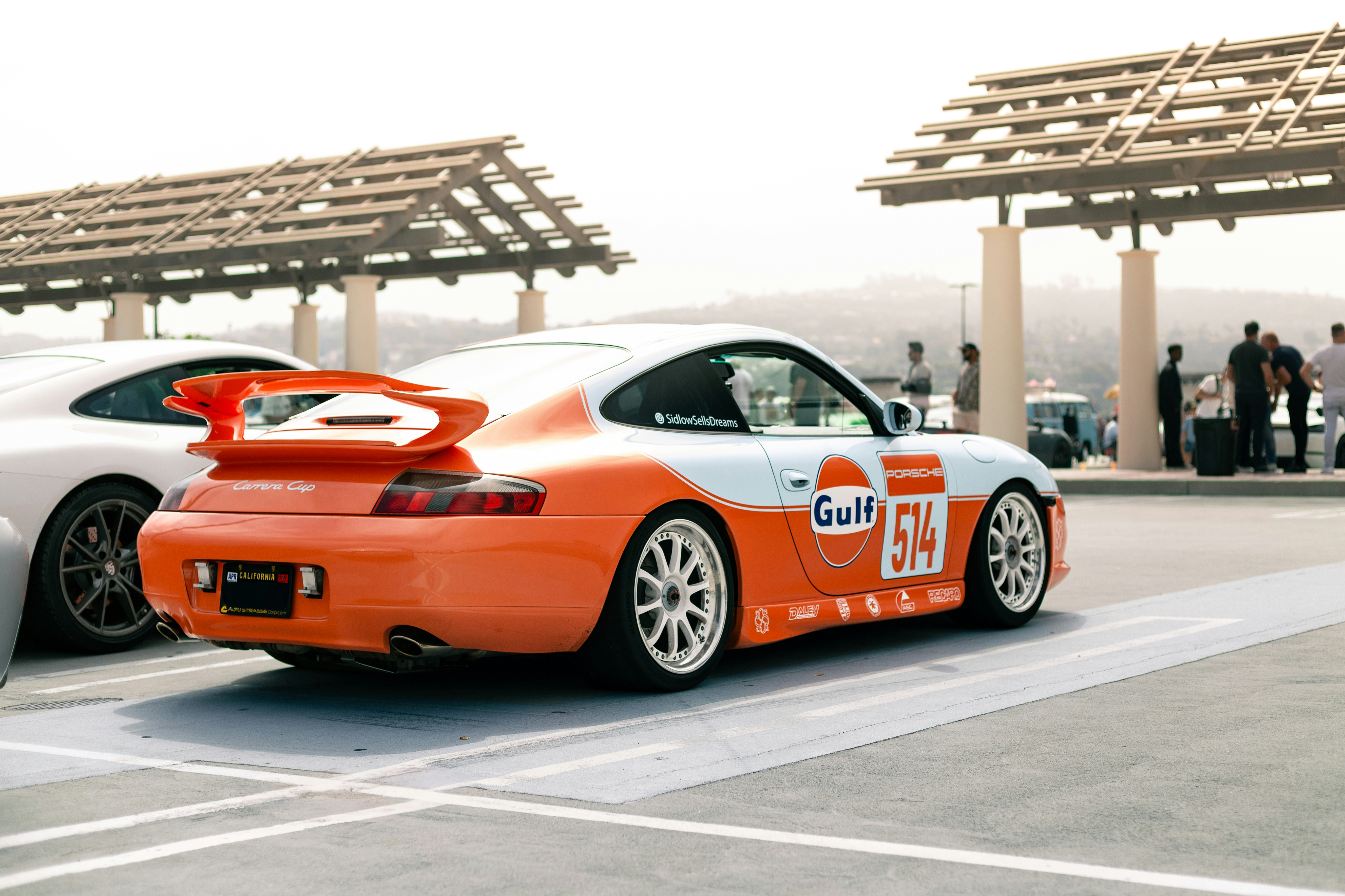 Orange Gulf Race Car at the Edge of the Pit Walk, Sunset Light Overhead