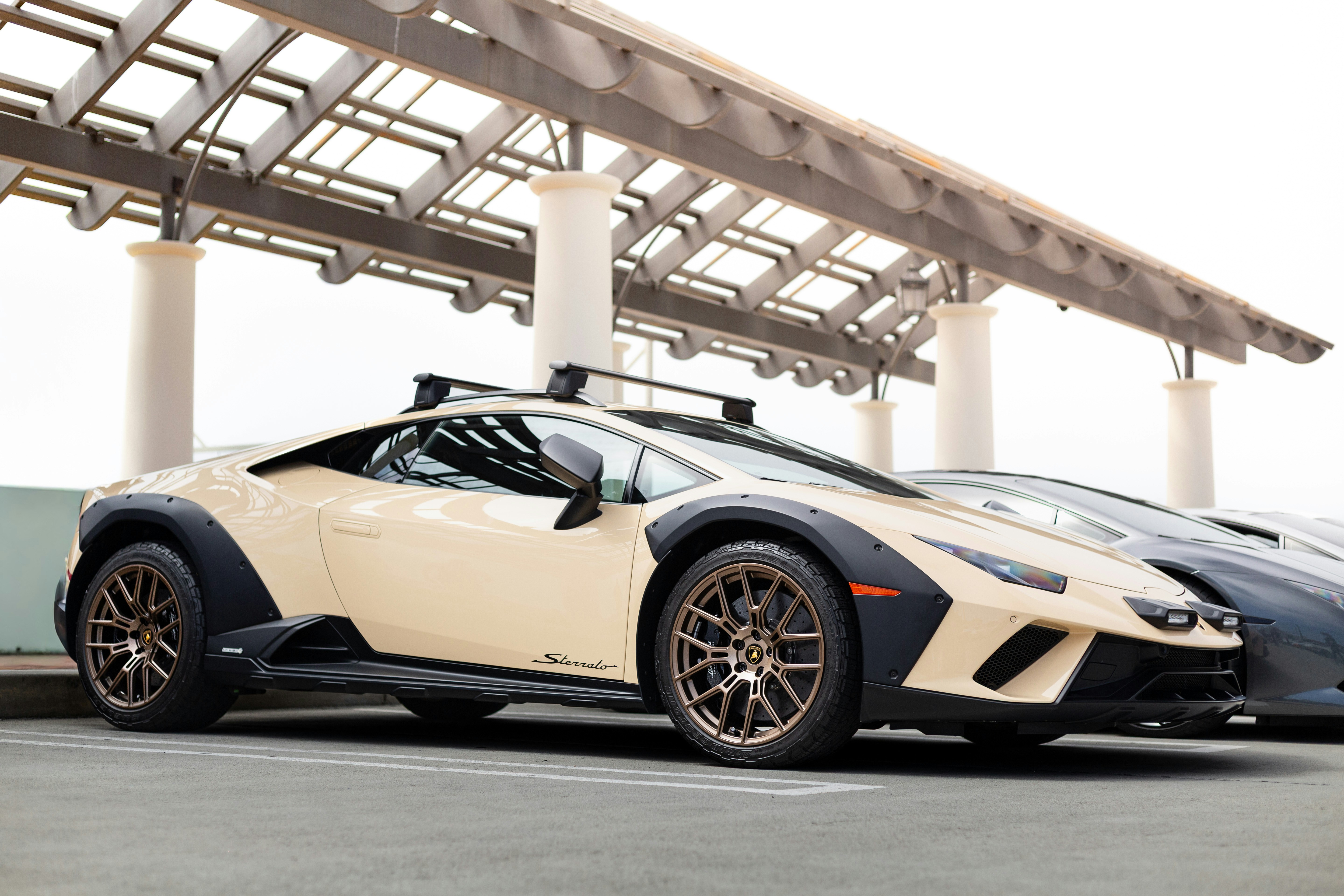 Cream-tinted Lamborghini Huracán Spyder at a Modern Parking Terrace