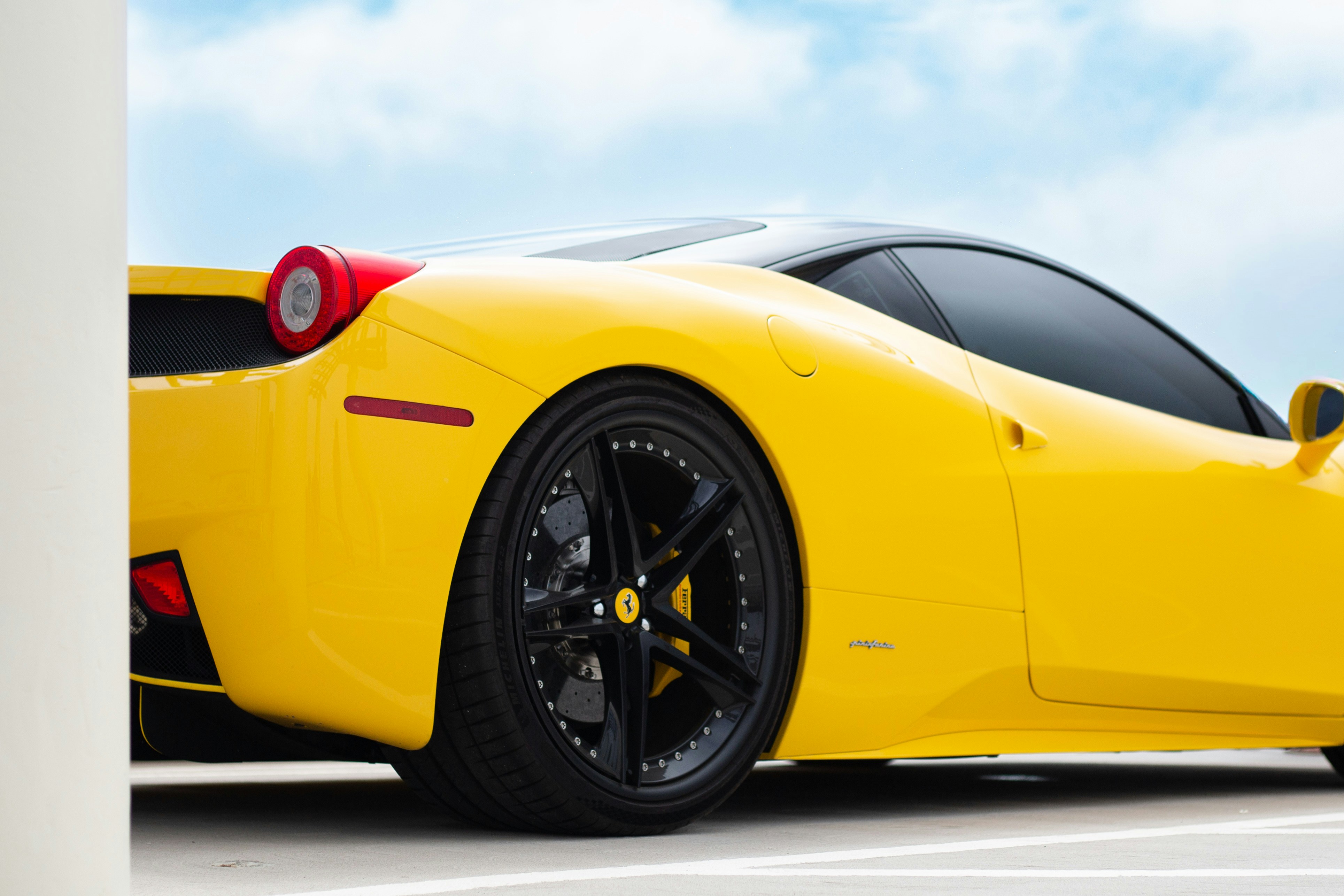 Crimson Ribbons: A Yellow Ferrari’s Low-Profile Grip
