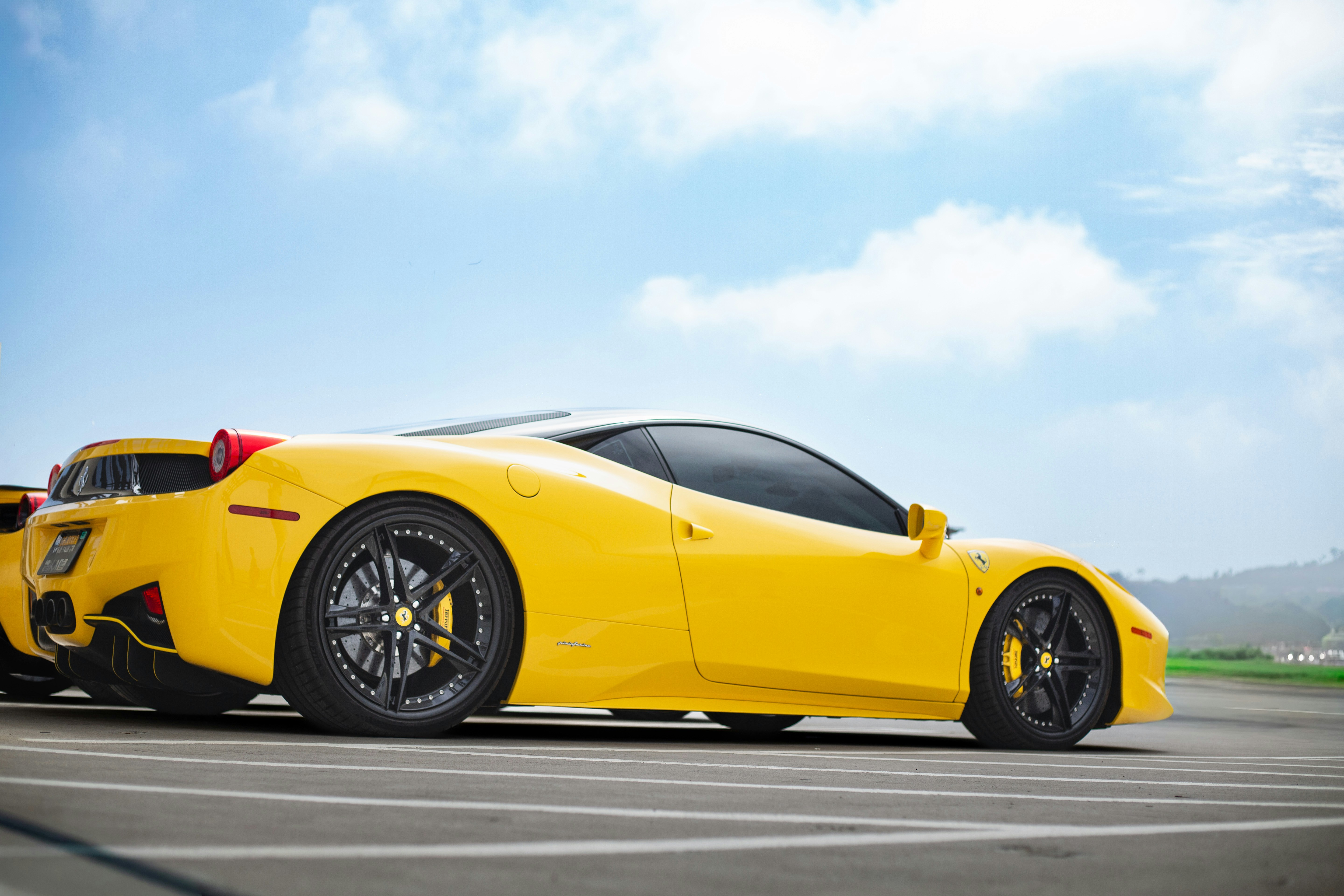 Yellow Expanse: A Low-Angle Stance of a Hypercar on an Open Tarmac