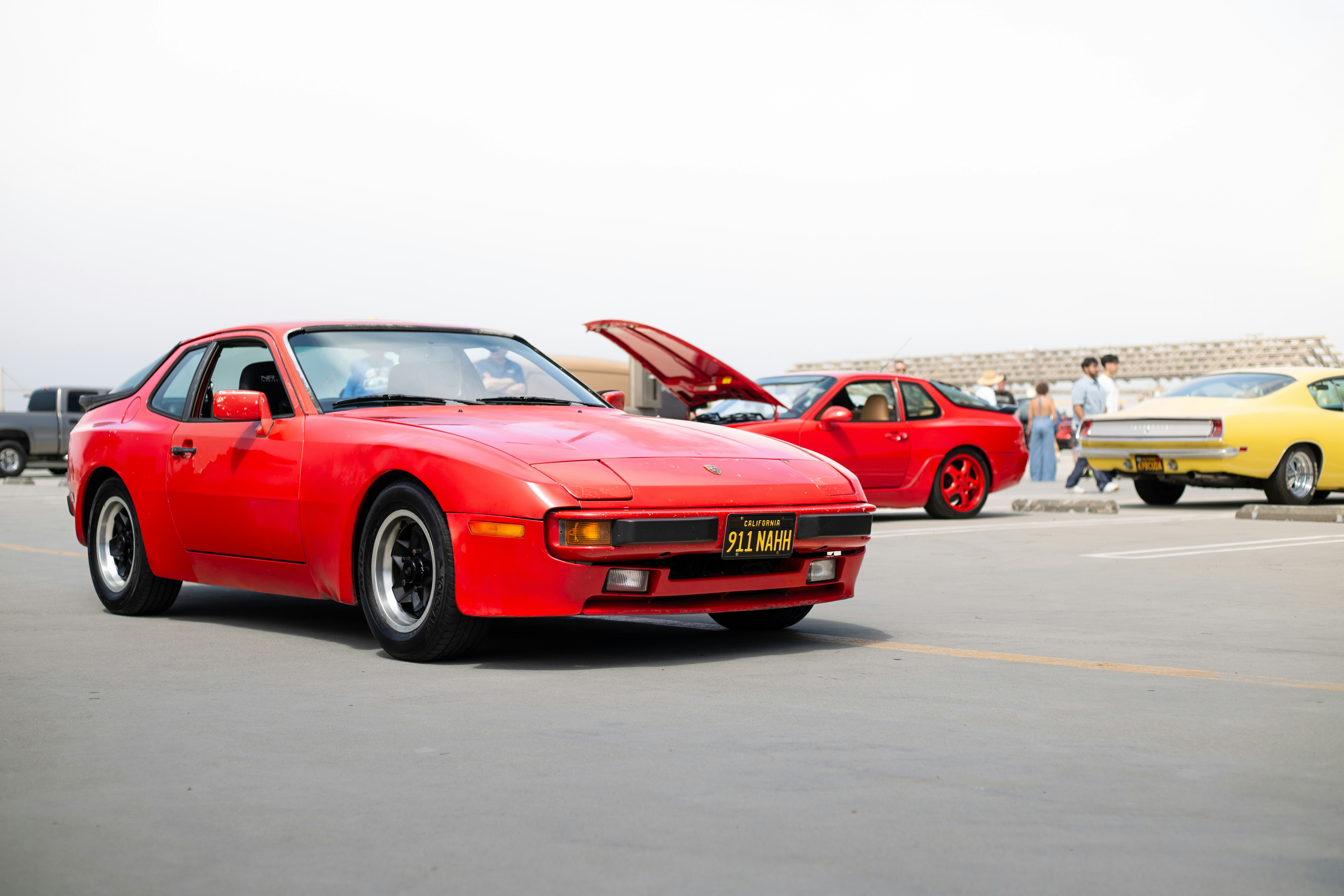 Red Delights on the Tarmac: A Quiet Car Show Moment