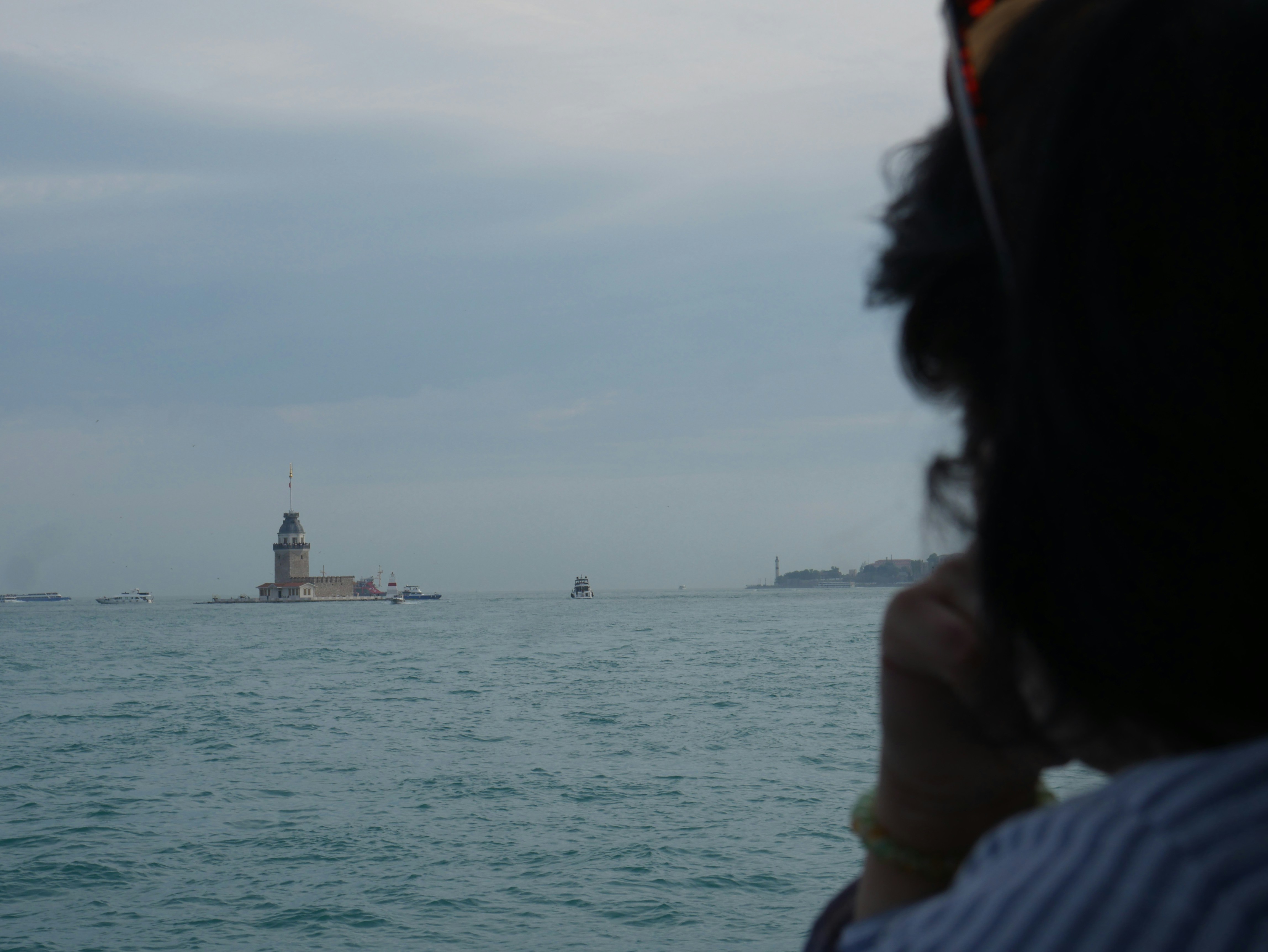 Observer by the Sea: A Silhouette Watches the Lighthouse